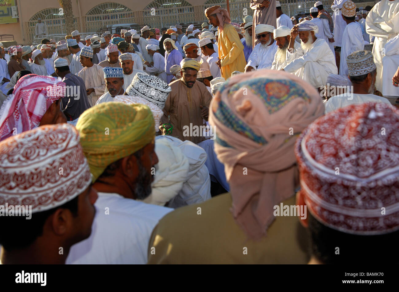 Local men dressed in the traditional Omani costume Dishdasha and the ...