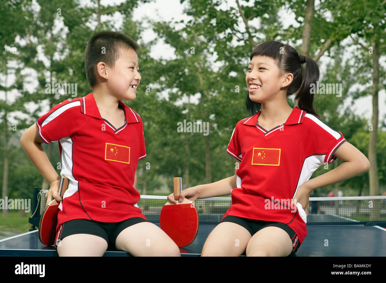 Children Sitting On Ping Pong Table Stock Photo - Alamy
