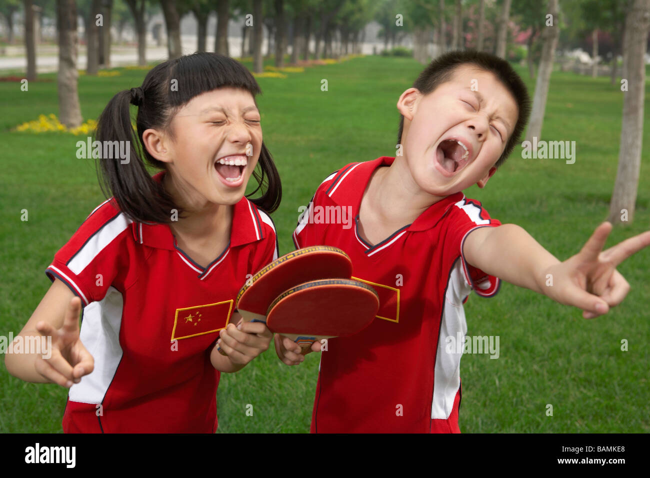 Children Holding Table Tennis Rackets Laughing Stock Photo - Alamy
