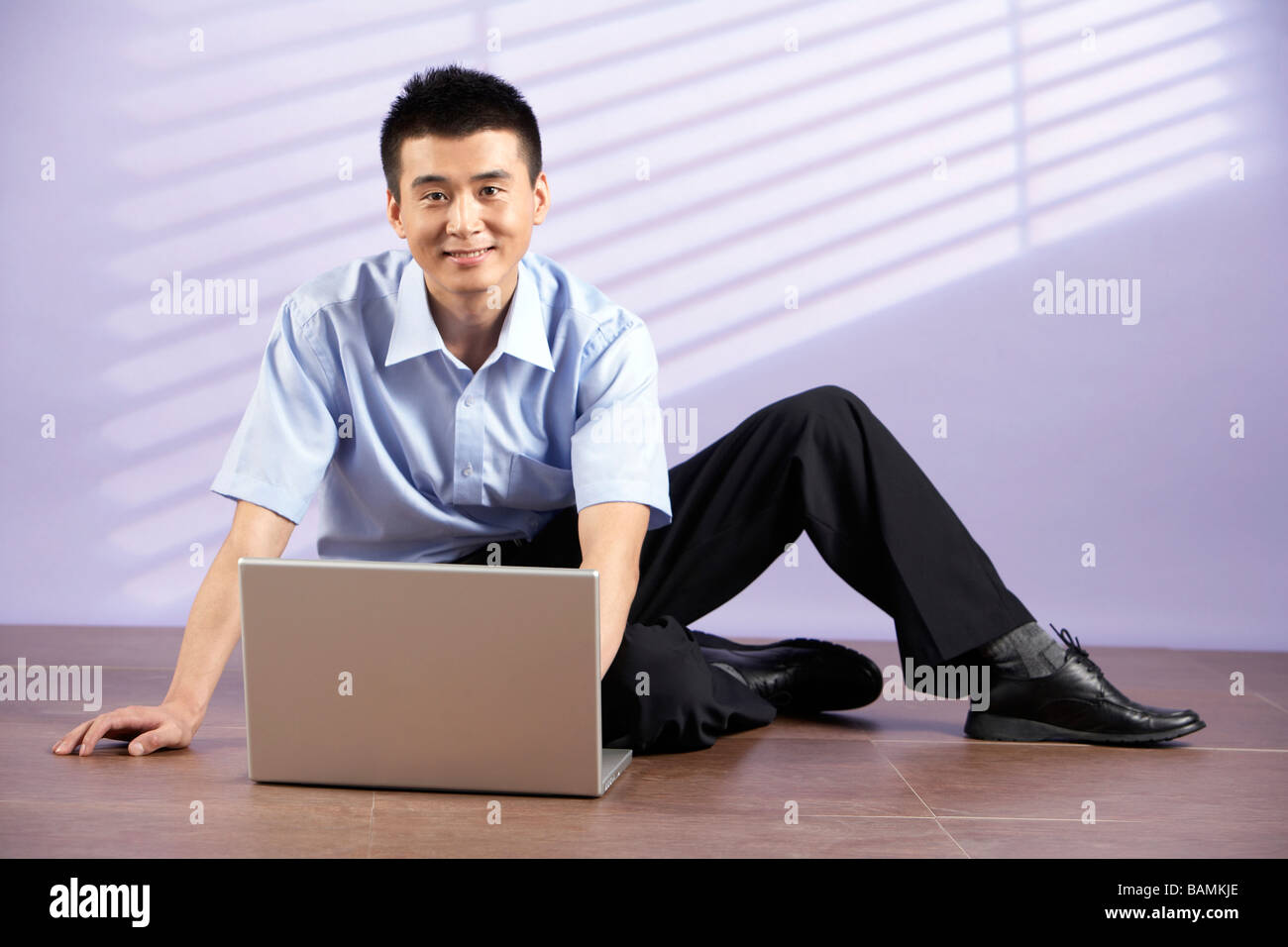 Man Sitting On Floor With A Computer Stock Photo - Alamy