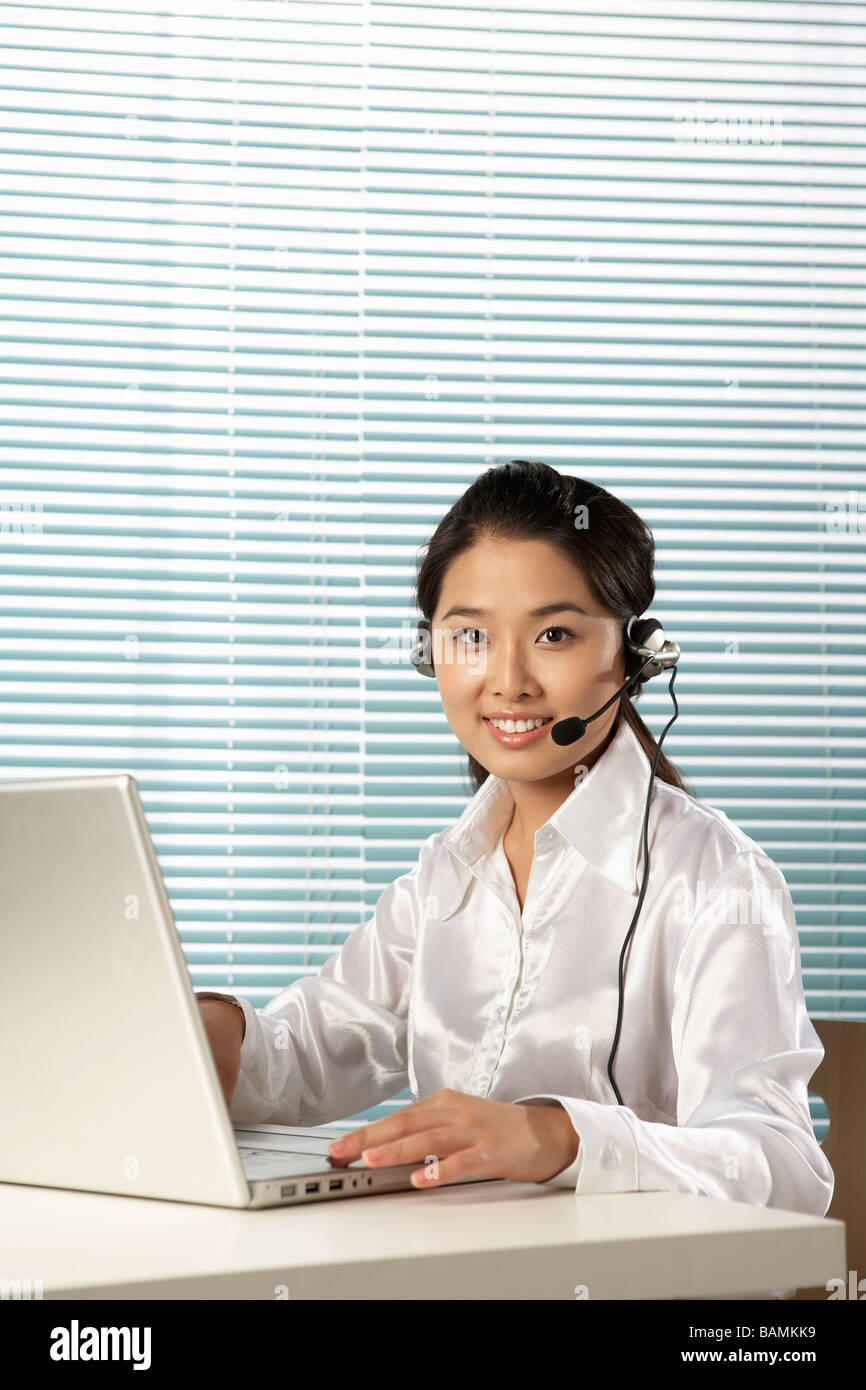 Merry woman using laptop headset hi-res stock photography and images ...