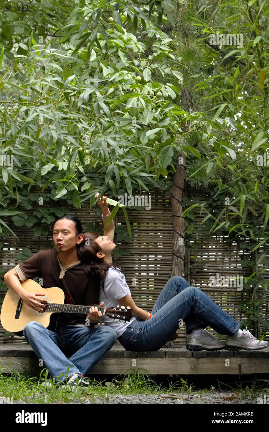 Cheerful couple playing musical instruments hi-res stock photography ...