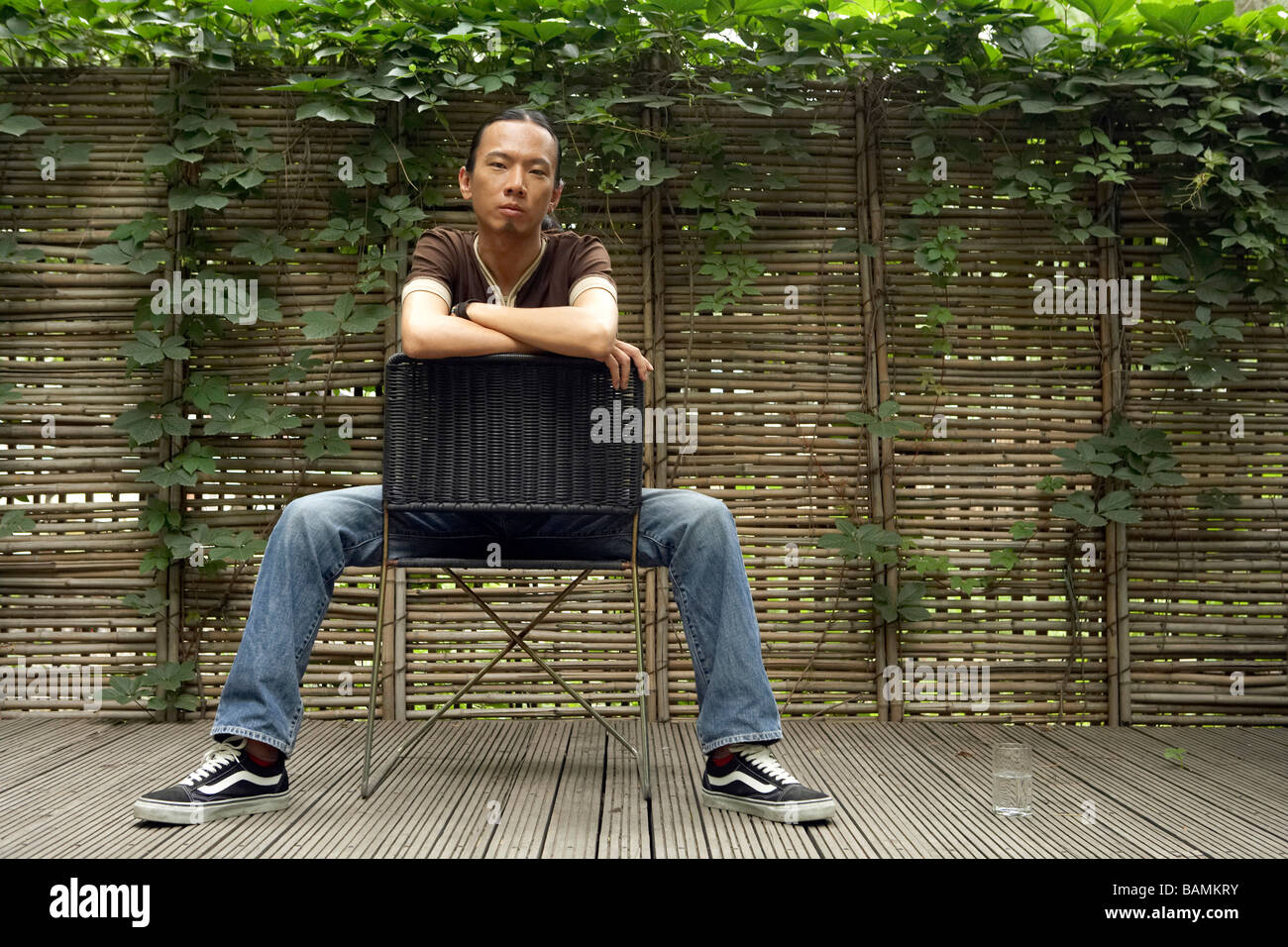 Man sitting backwards chair hi-res stock photography and images - Alamy