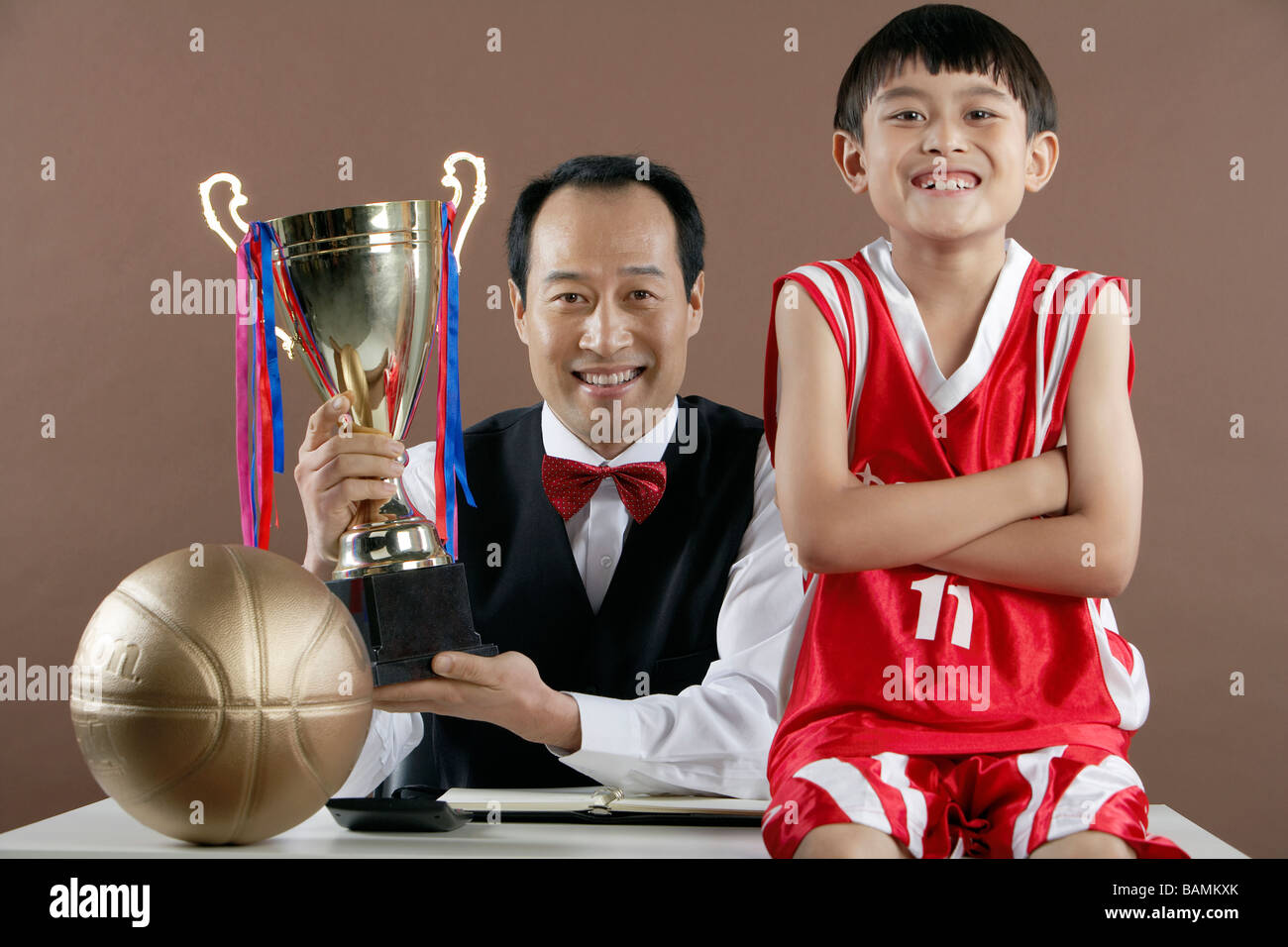 Father And Son Smiling, Father Holding Trophy Stock Photo - Alamy