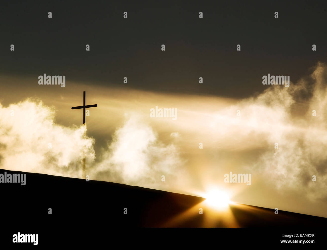 The cross on a hilltop with the sunrise Stock Photo - Alamy