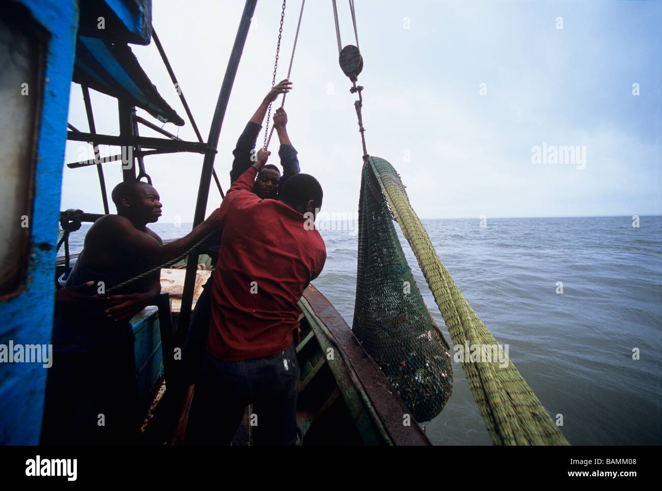 Fisherman bring up net full of shrimp and bycatch onboard semi ...