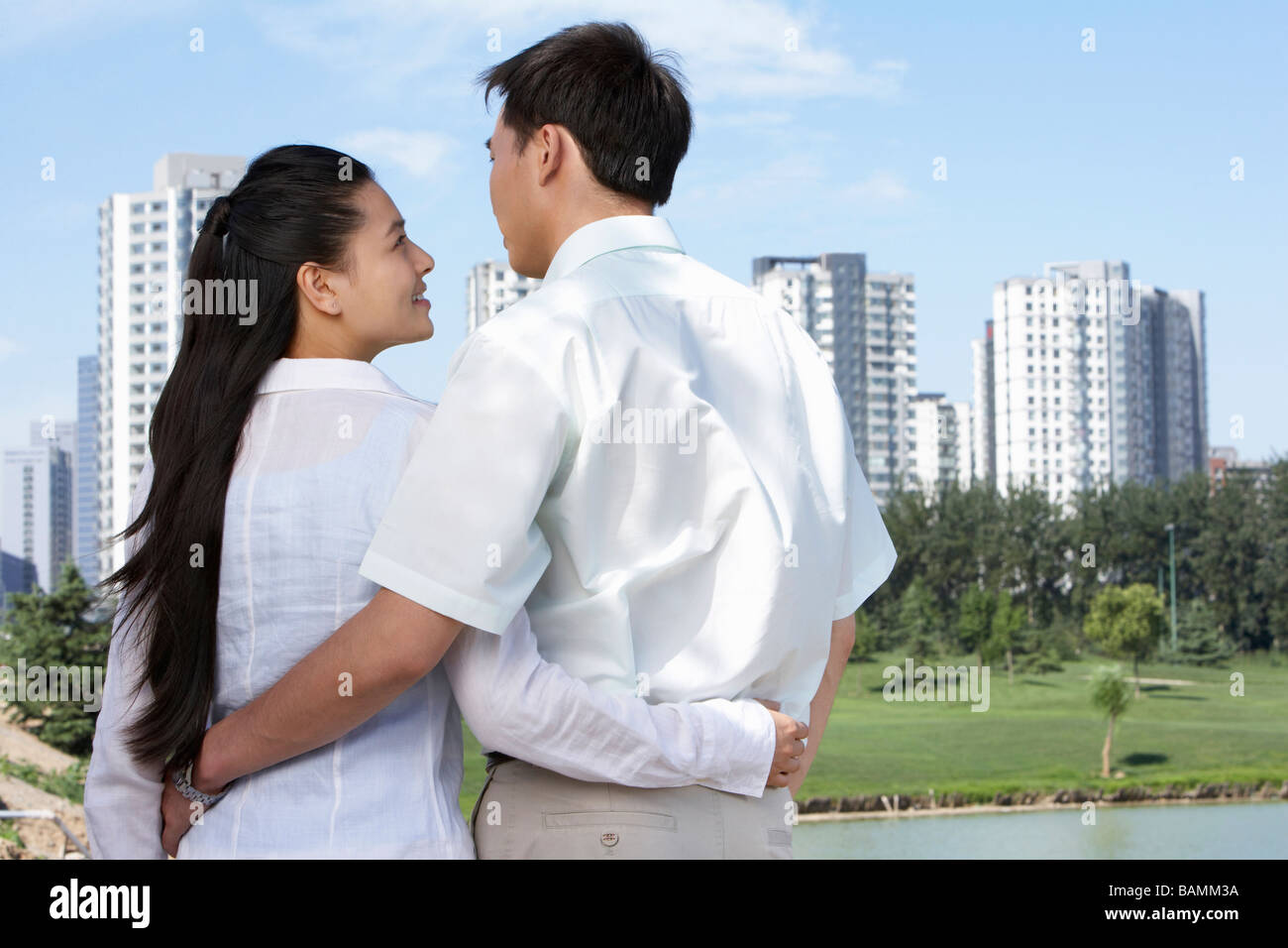 Rear View Of Man And Woman Hugging And Smiling At Each Other Stock ...