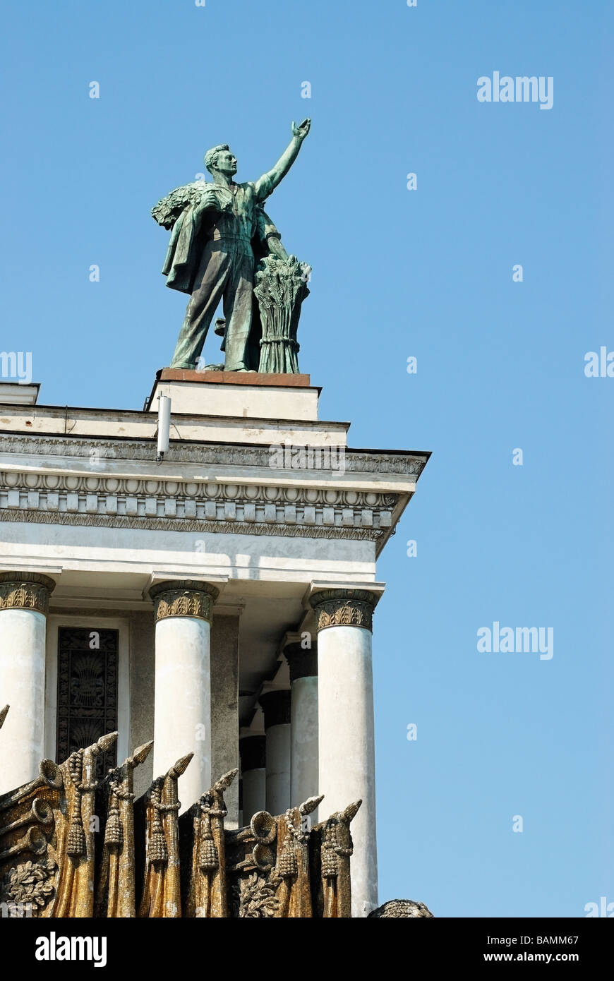 Bronze statue of Soviet worker above a central pavilion on VVTs Moscow ...