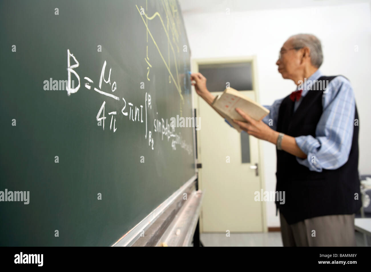 Teacher Writing On Blackboard High Resolution Stock Photography and ...