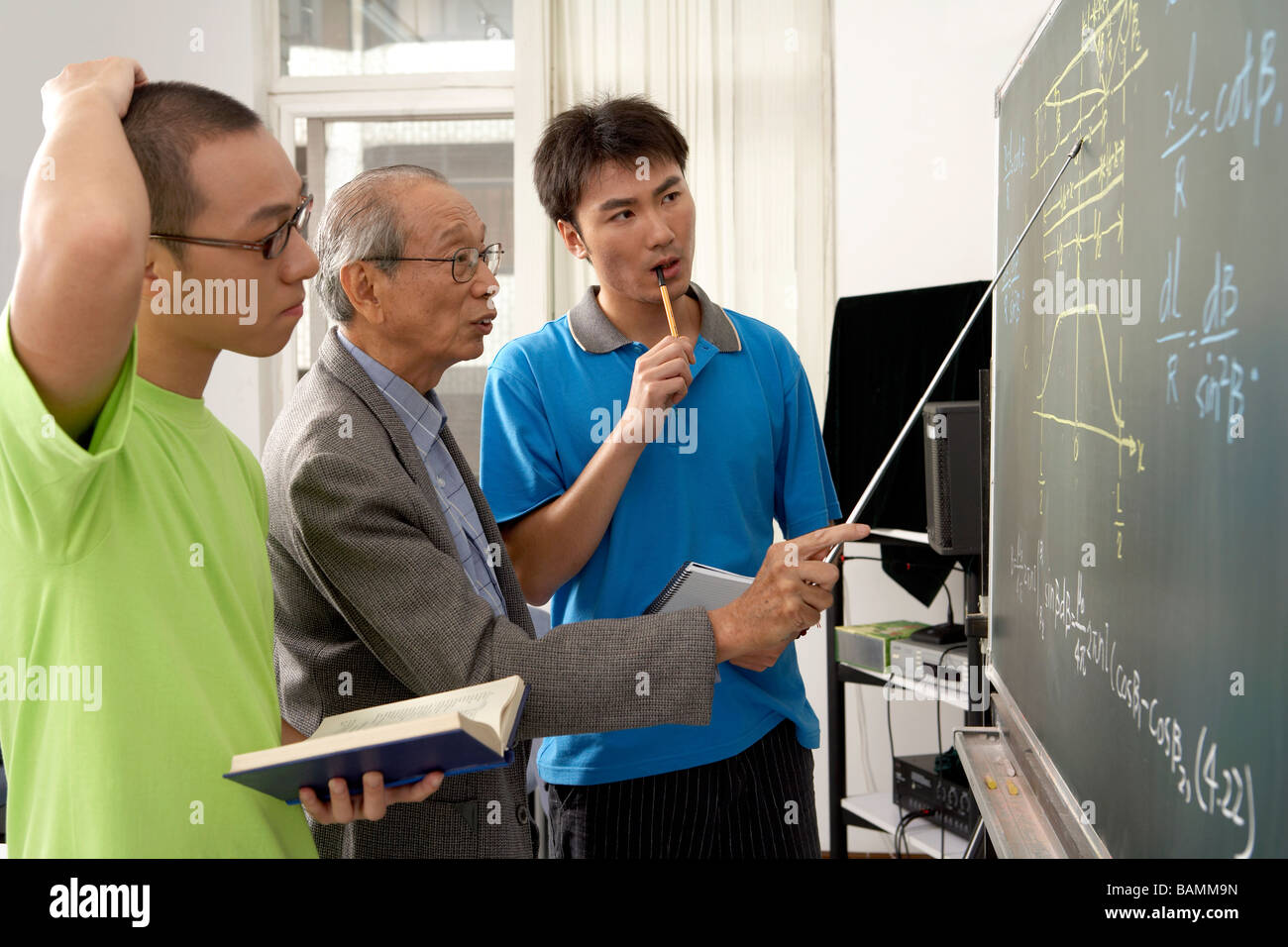Teacher Lecturing Students In A Class Room Stock Photo - Alamy
