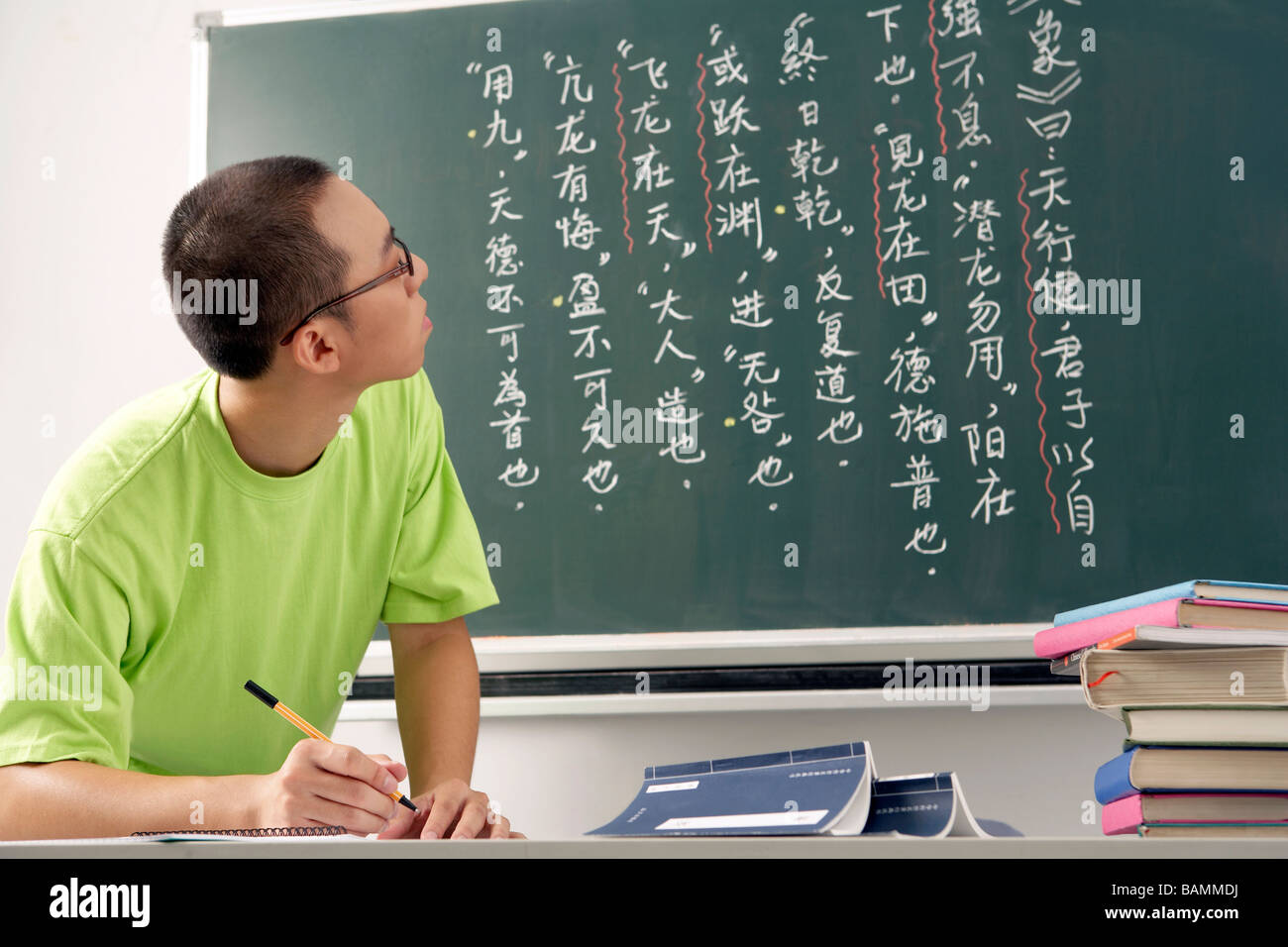 Man Looking At Blackboard, Taking Notes Stock Photo - Alamy