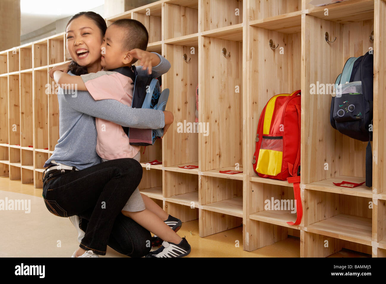 Mother Hugging Son At School Stock Photo - Alamy