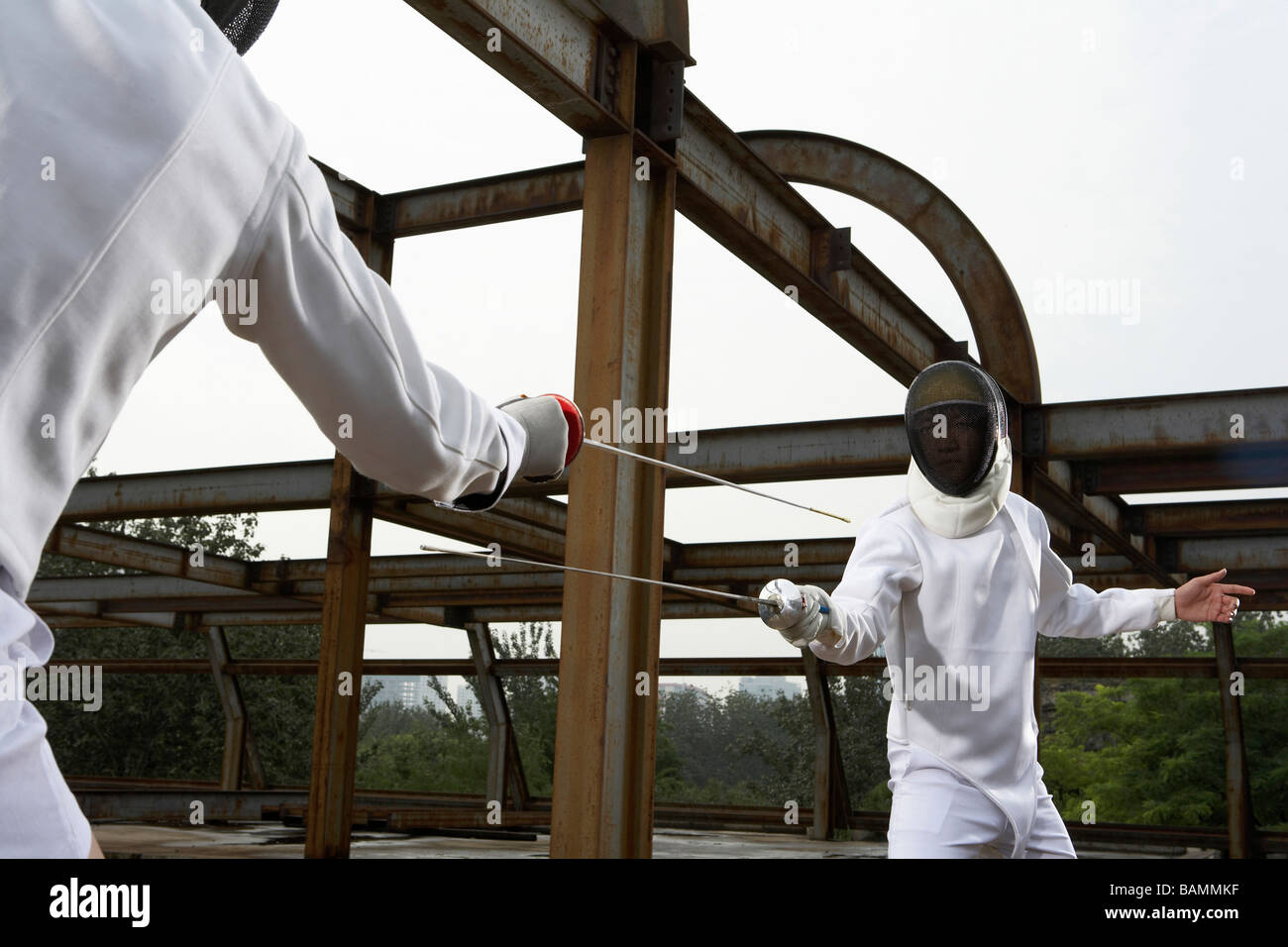 Young Men Fencing In A Construction Site Stock Photo - Alamy