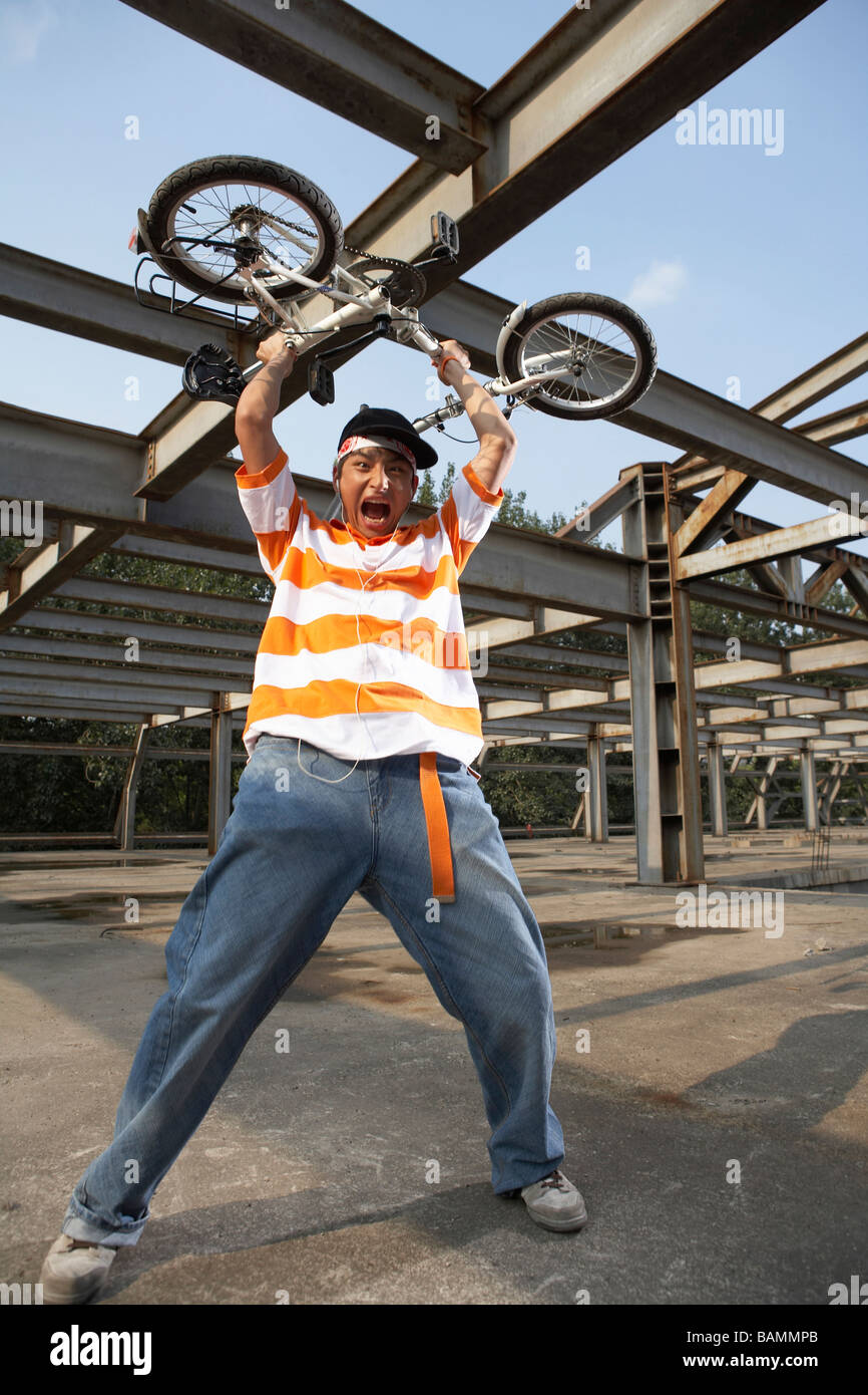 Man Lifting Bike Up Stock Photo - Alamy