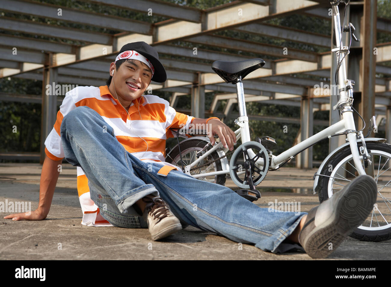 Man Sitting Down Next To Bike Stock Photo - Alamy