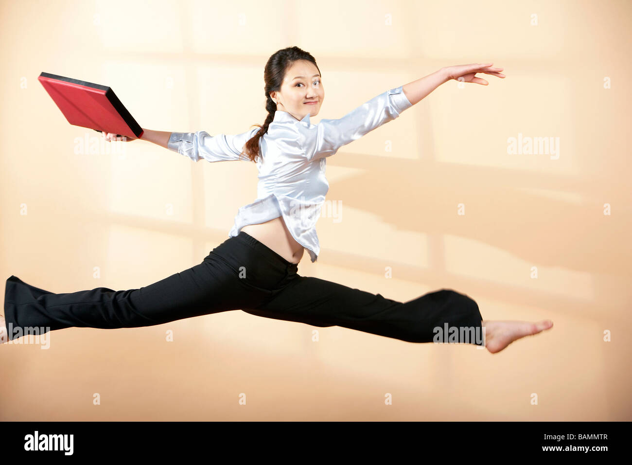 Woman Leaping Through The Air Stock Photo - Alamy
