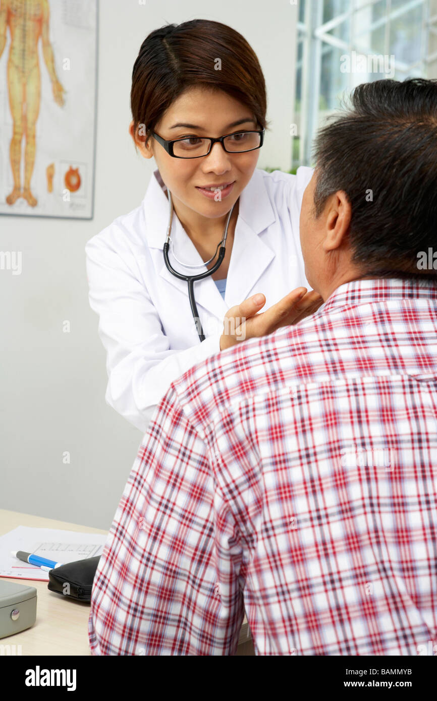 Doctor Checking Man's Throat Stock Photo - Alamy