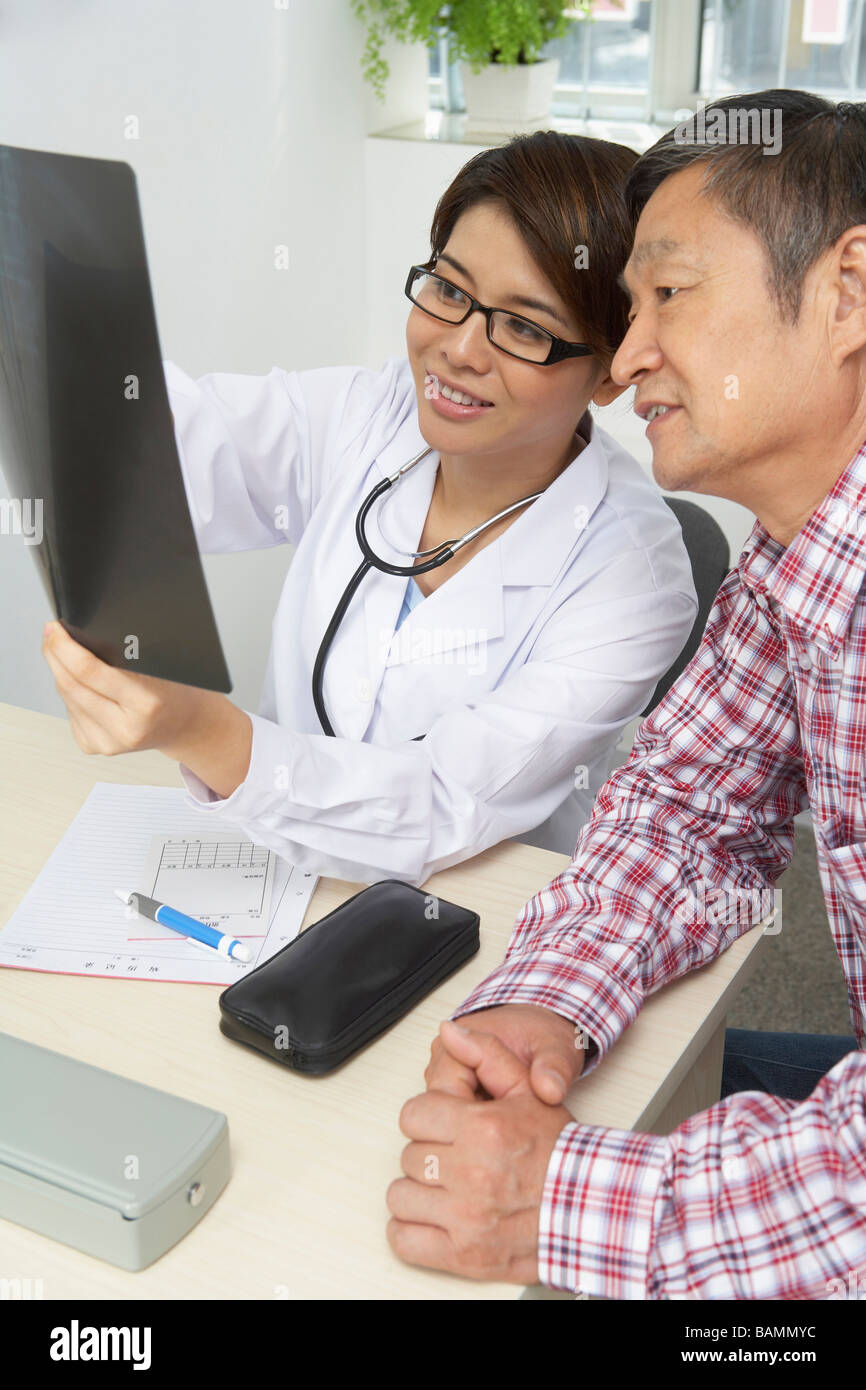Doctor Explaining X-Ray To Patient Stock Photo - Alamy