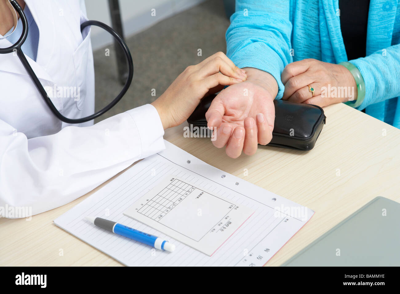 Doctor Checking Patient's Pulse Stock Photo - Alamy