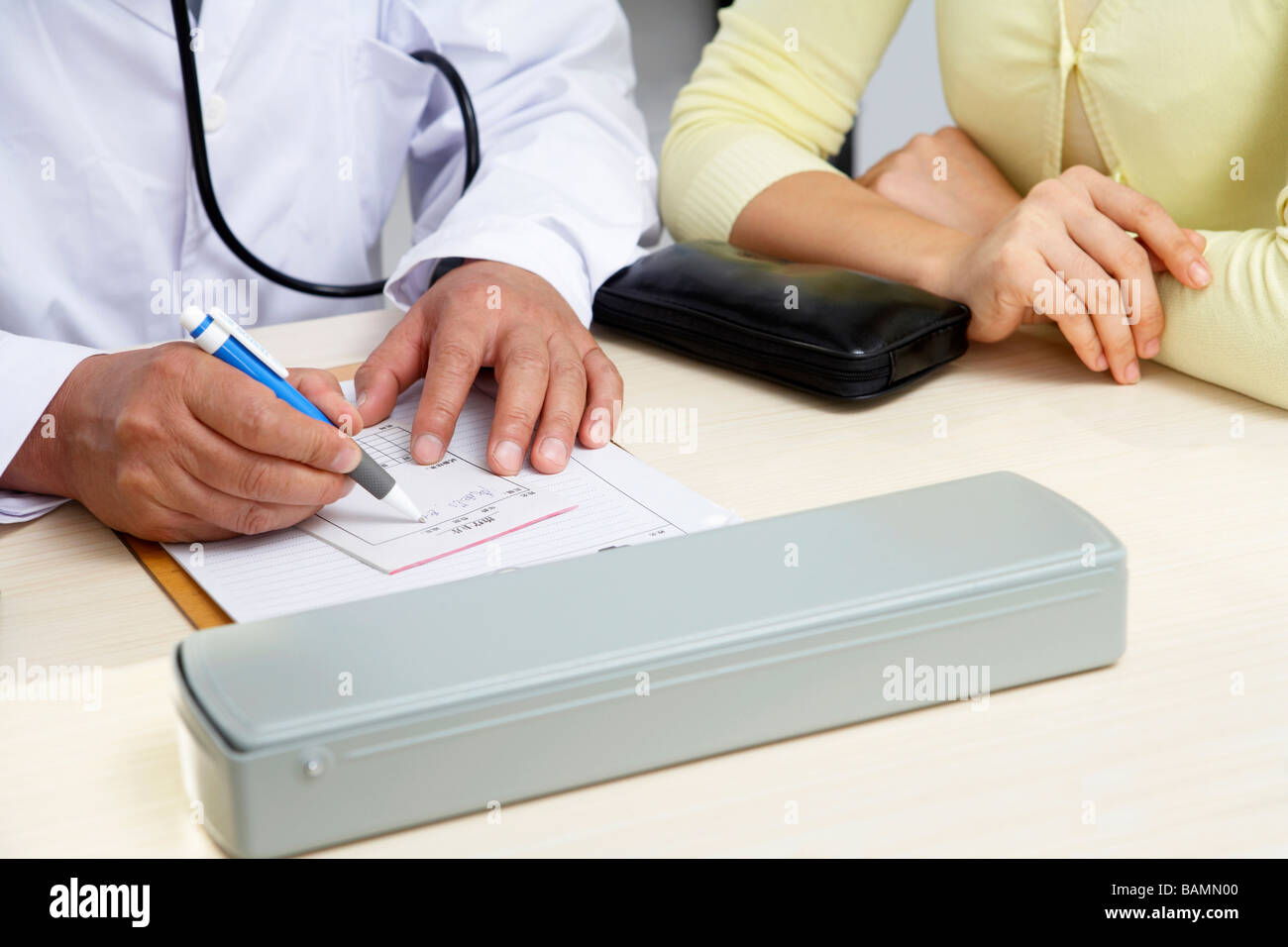 Doctor sits writing hi-res stock photography and images - Alamy