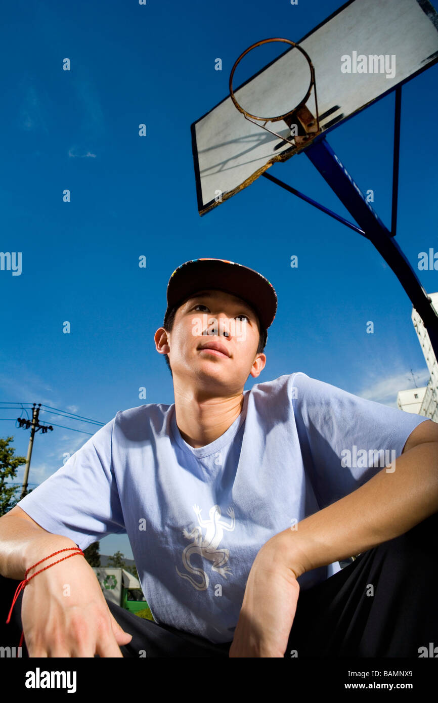 Teenage Boy Crouching On Basketball Court Stock Photo - Alamy