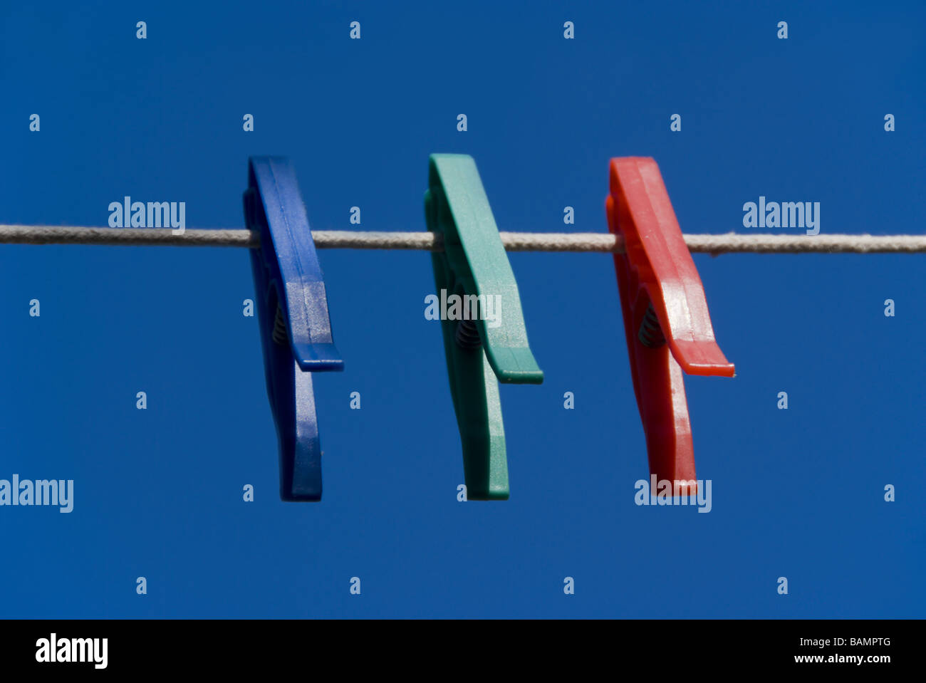 Red green and blue plastic clothes pegs on a washing line Stock Photo ...