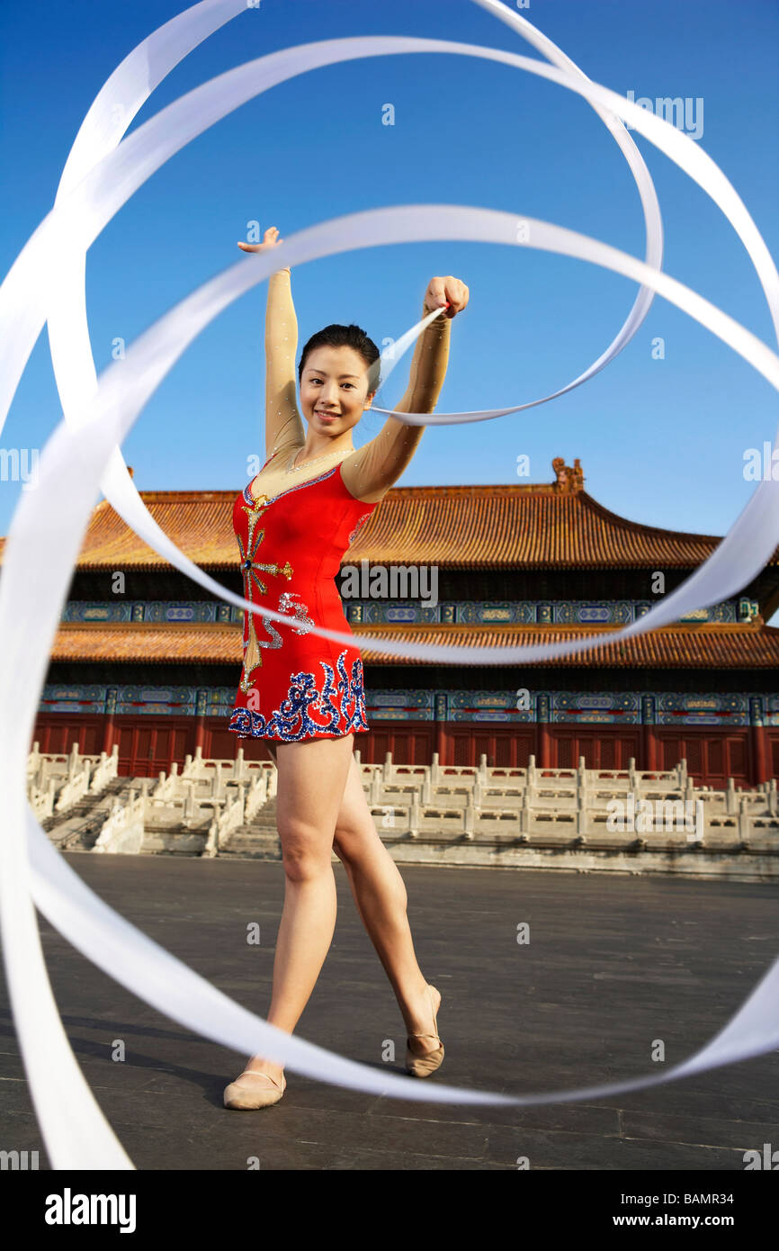 Young Woman Ribbon Dancing In Front Of A Temple Stock Photo - Alamy