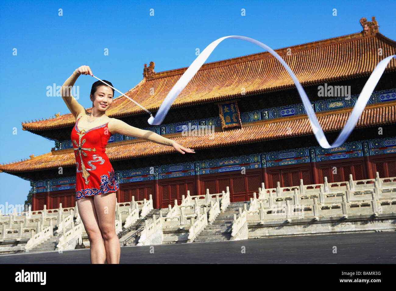 Young Woman Ribbon Dancing In Front Of A Temple Stock Photo - Alamy