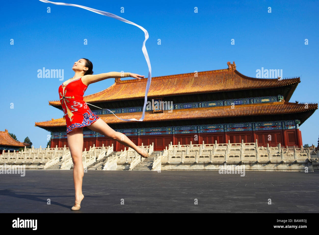 Young Woman Ribbon Dancing In Front Of A Temple Stock Photo - Alamy