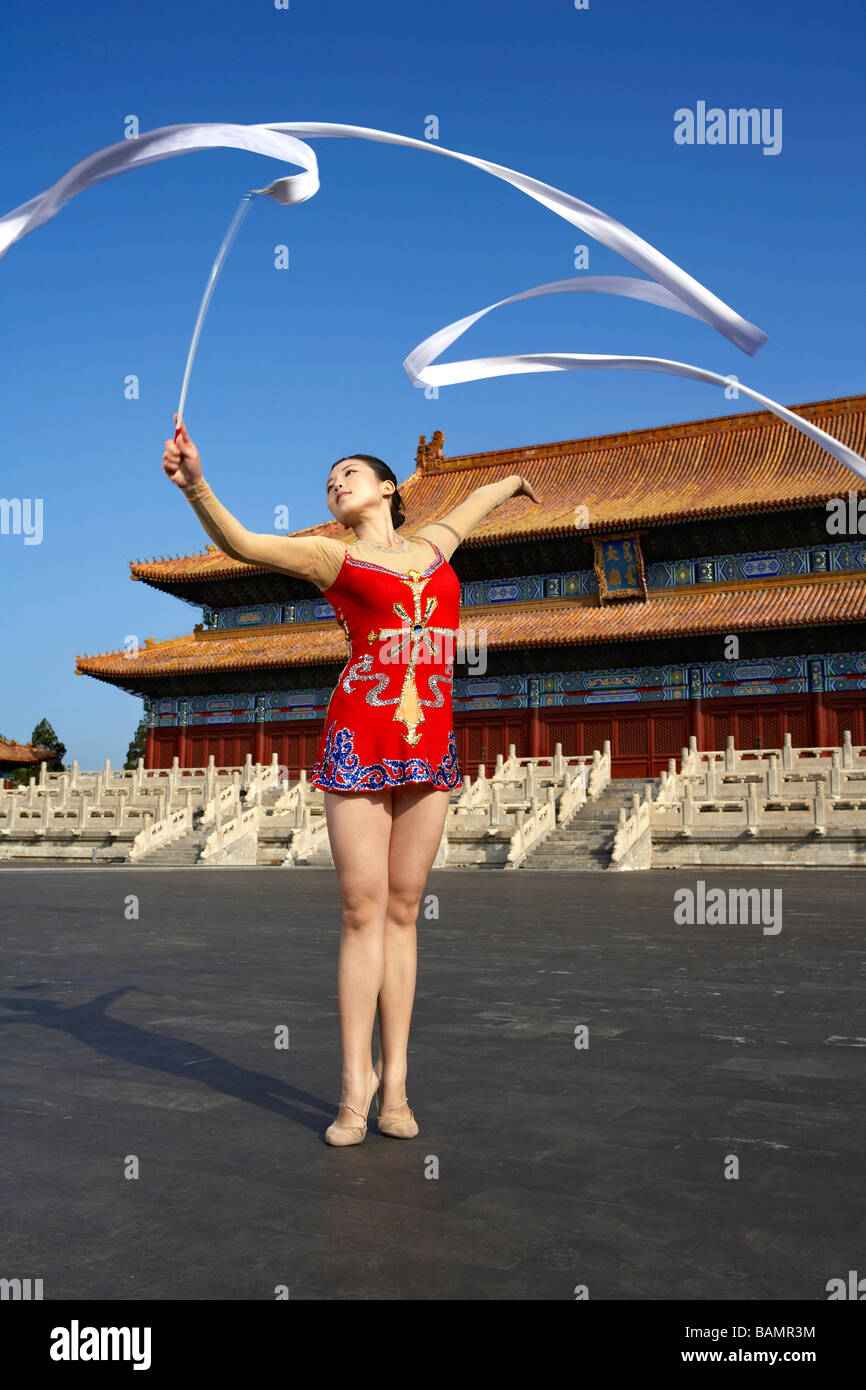 Young Woman Ribbon Dancing In Front Of A Temple Stock Photo - Alamy