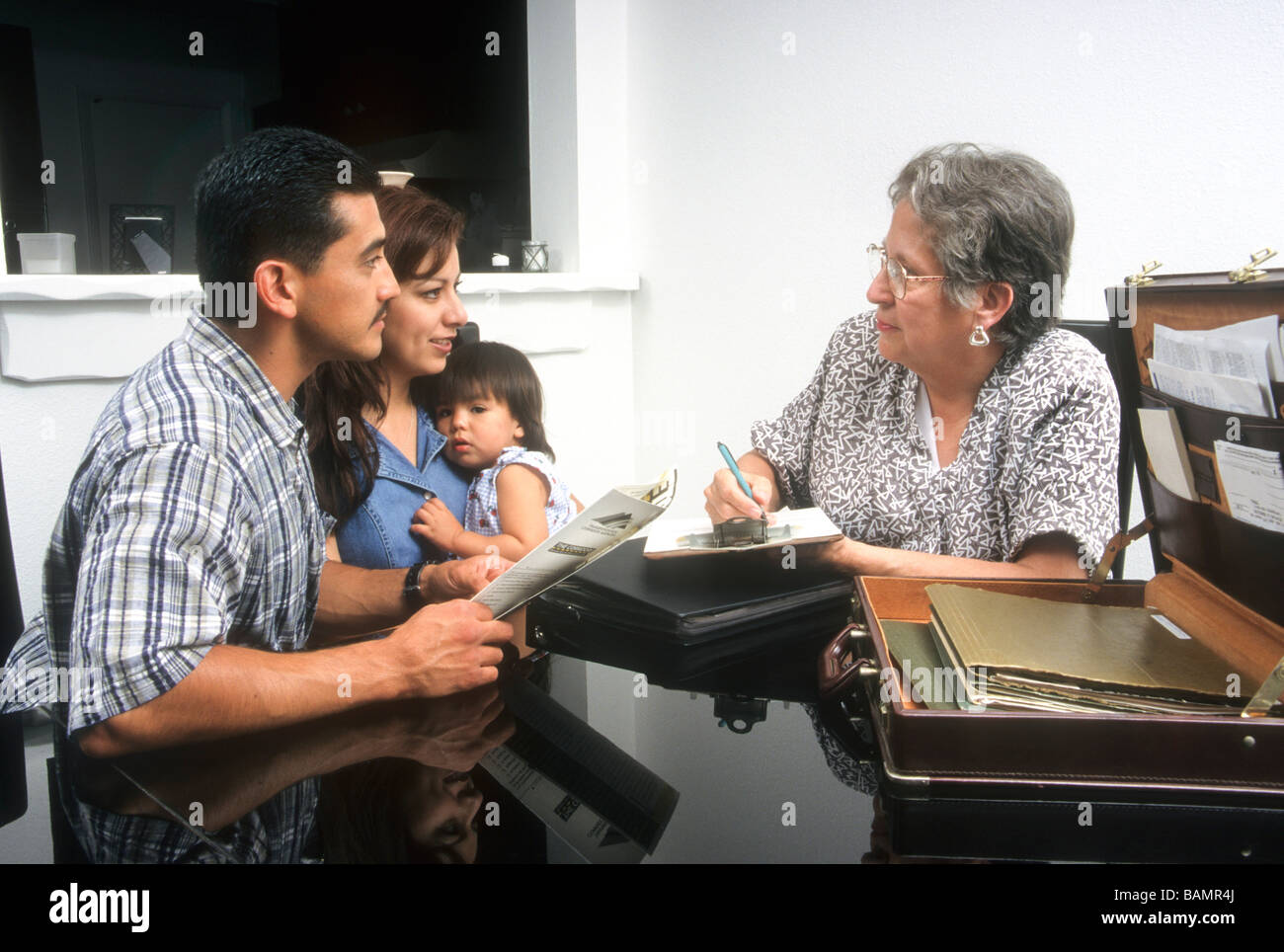 Woman interview Hispanic couple mother father mom dad family child baby ...