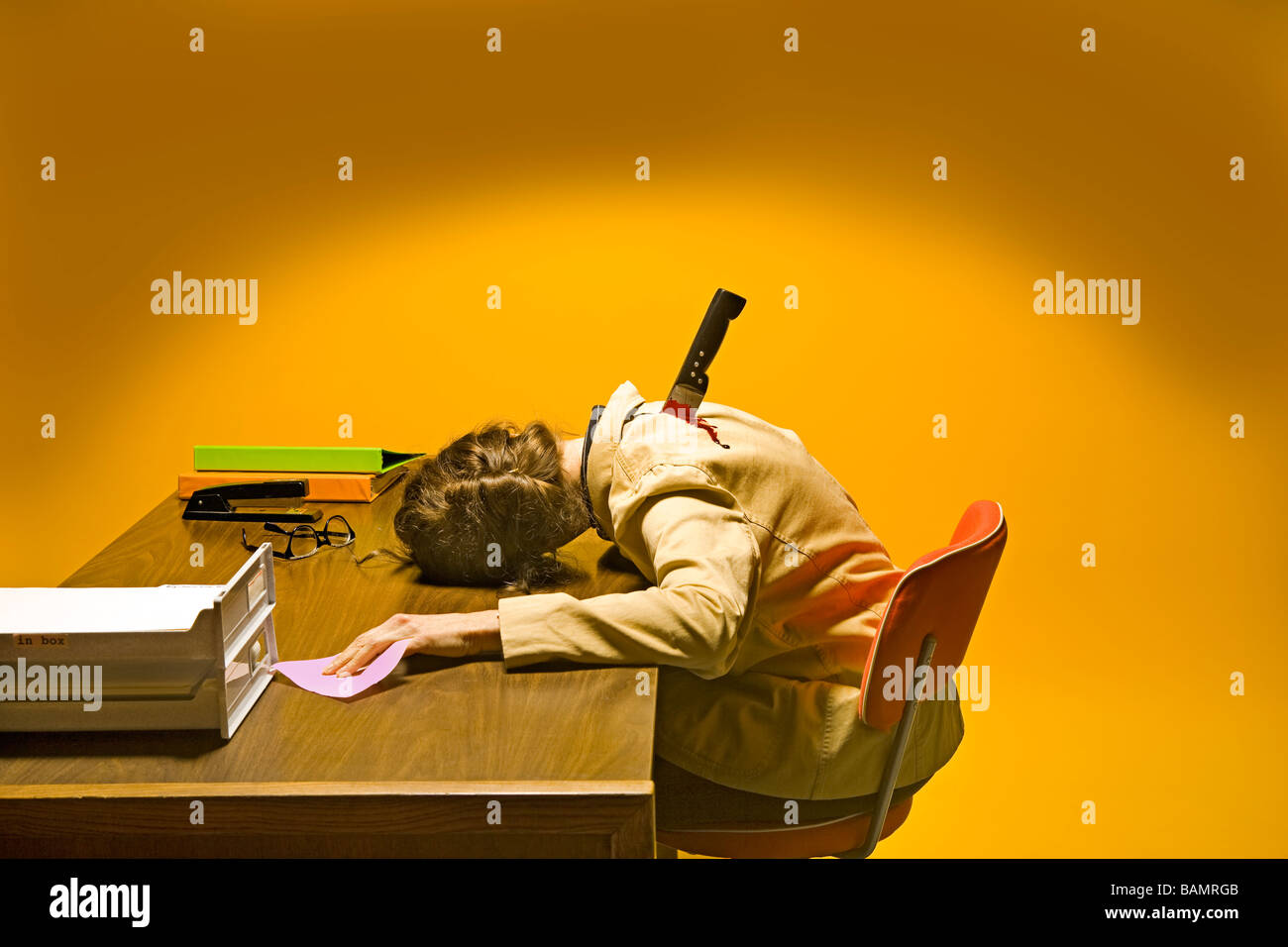 Stabbed in the back at the office Stock Photo - Alamy