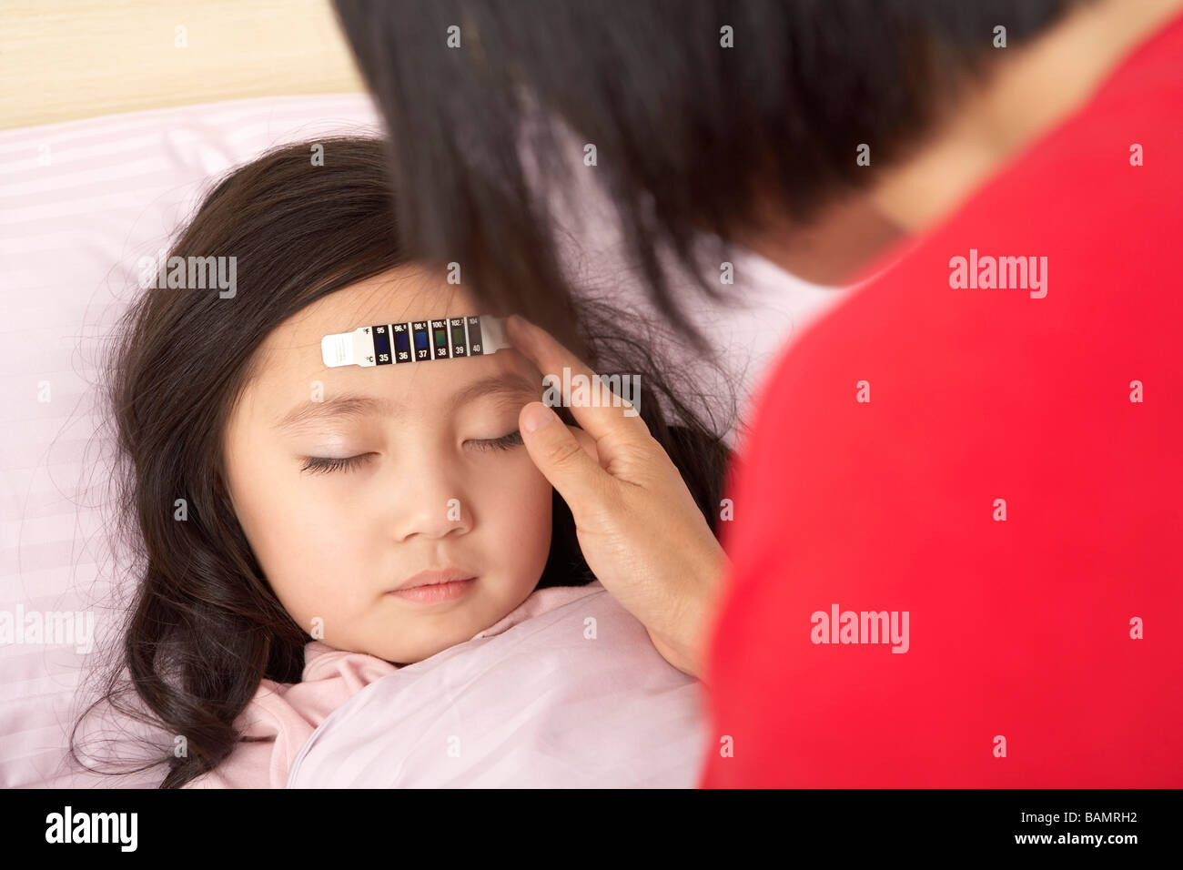 Mother Checking Sick Daughter's Temperature Stock Photo - Alamy