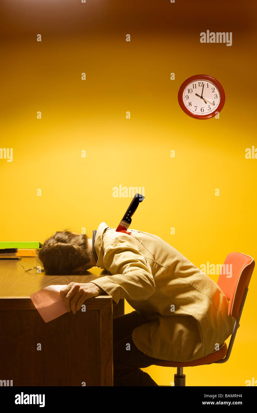 Stabbed in the back at the office Stock Photo - Alamy