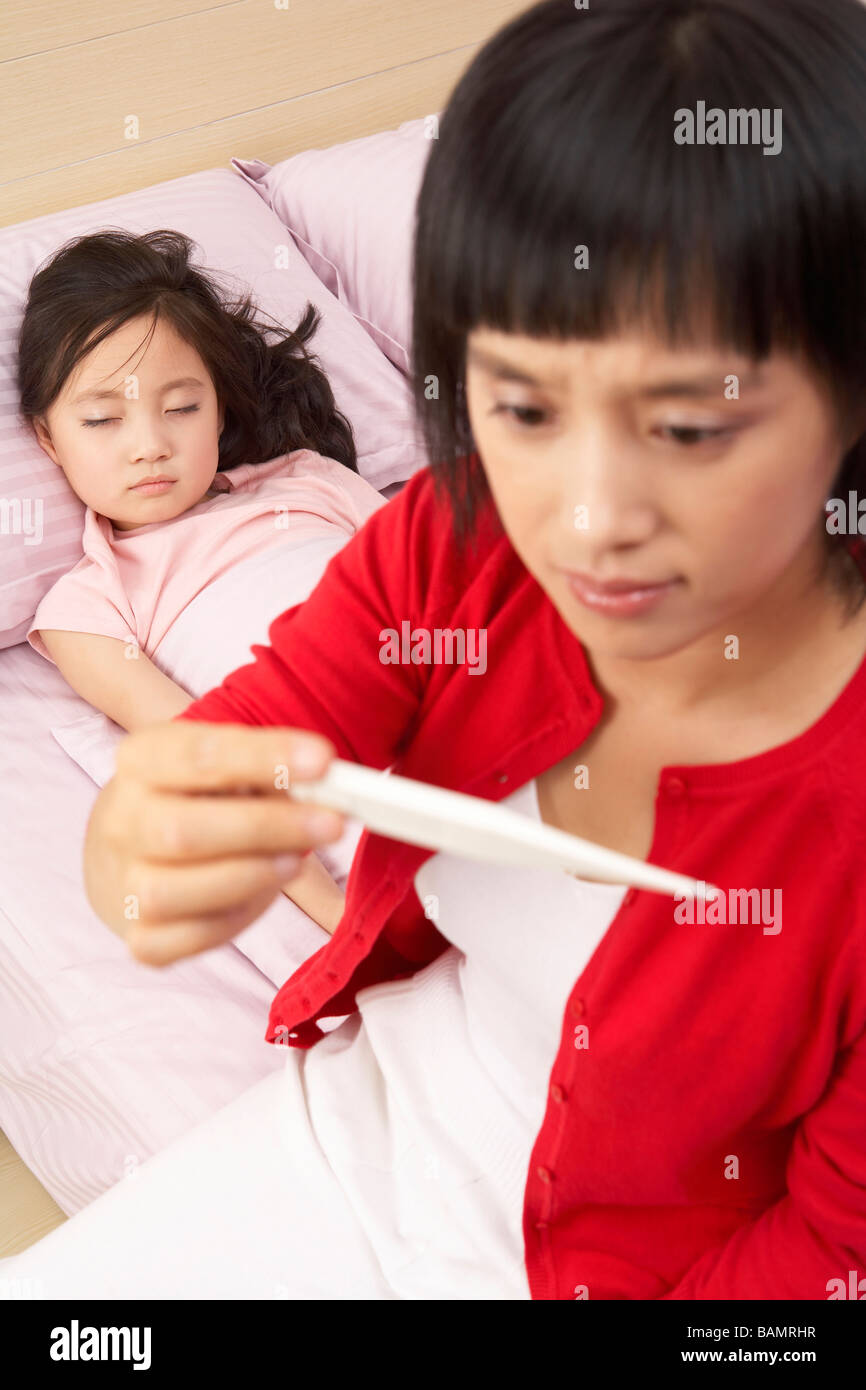 Mother Checking Sick Daughter's Temperature Stock Photo - Alamy