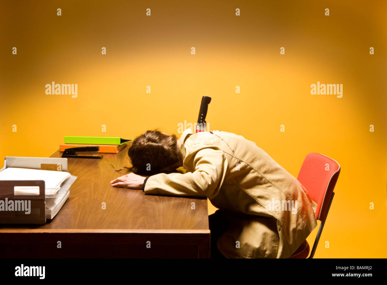 Stabbed in the back at the office Stock Photo - Alamy