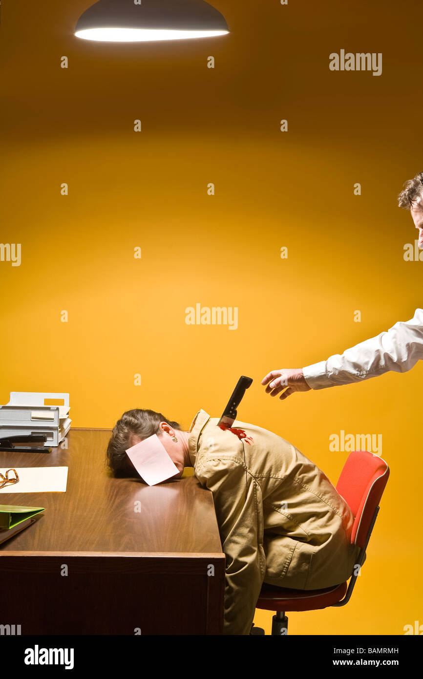 Stabbed in the back at the office Stock Photo - Alamy