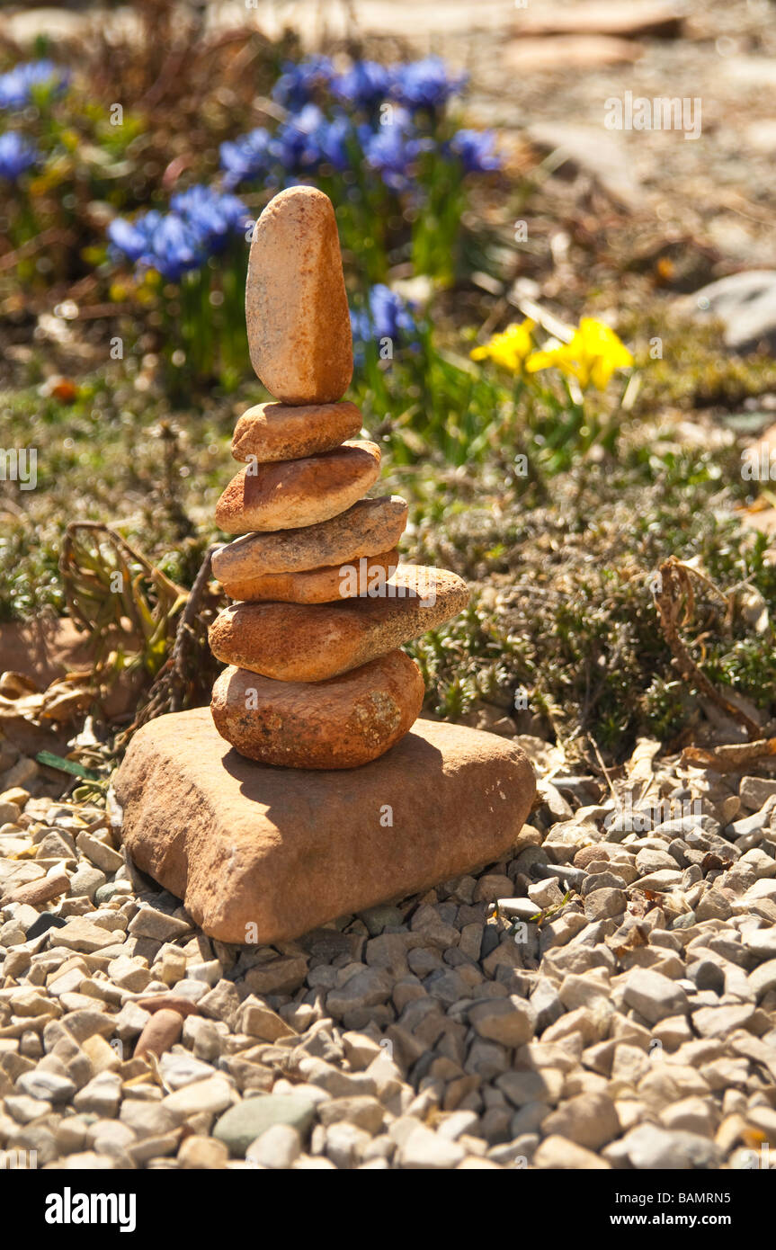 Balanced rocks in a flower garden Stock Photo - Alamy