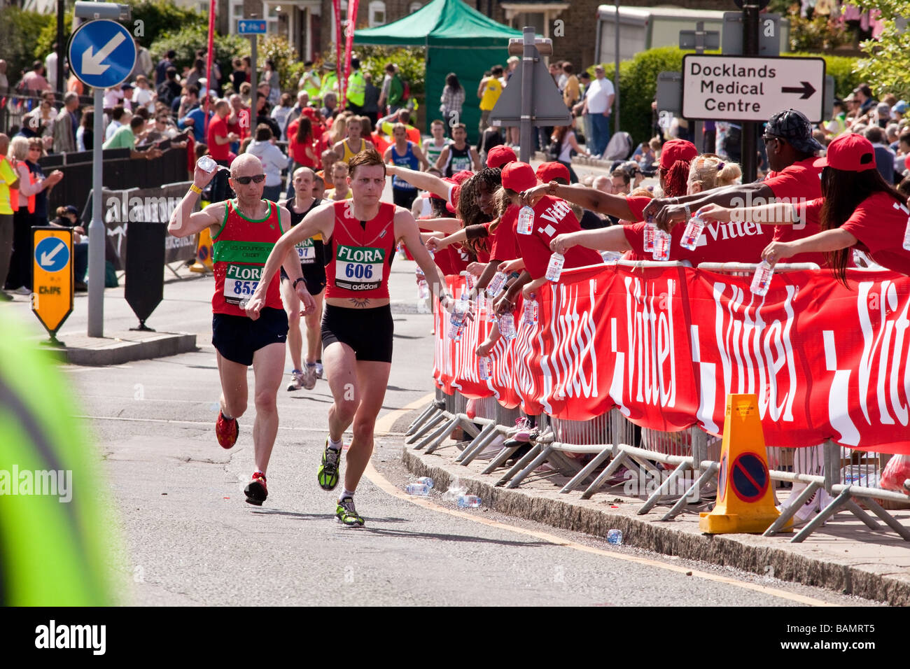 Runners on the London Marathon 2009 at the Vittel water station near ...