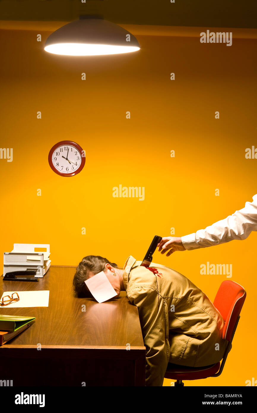 Stabbed in the back at the office Stock Photo - Alamy