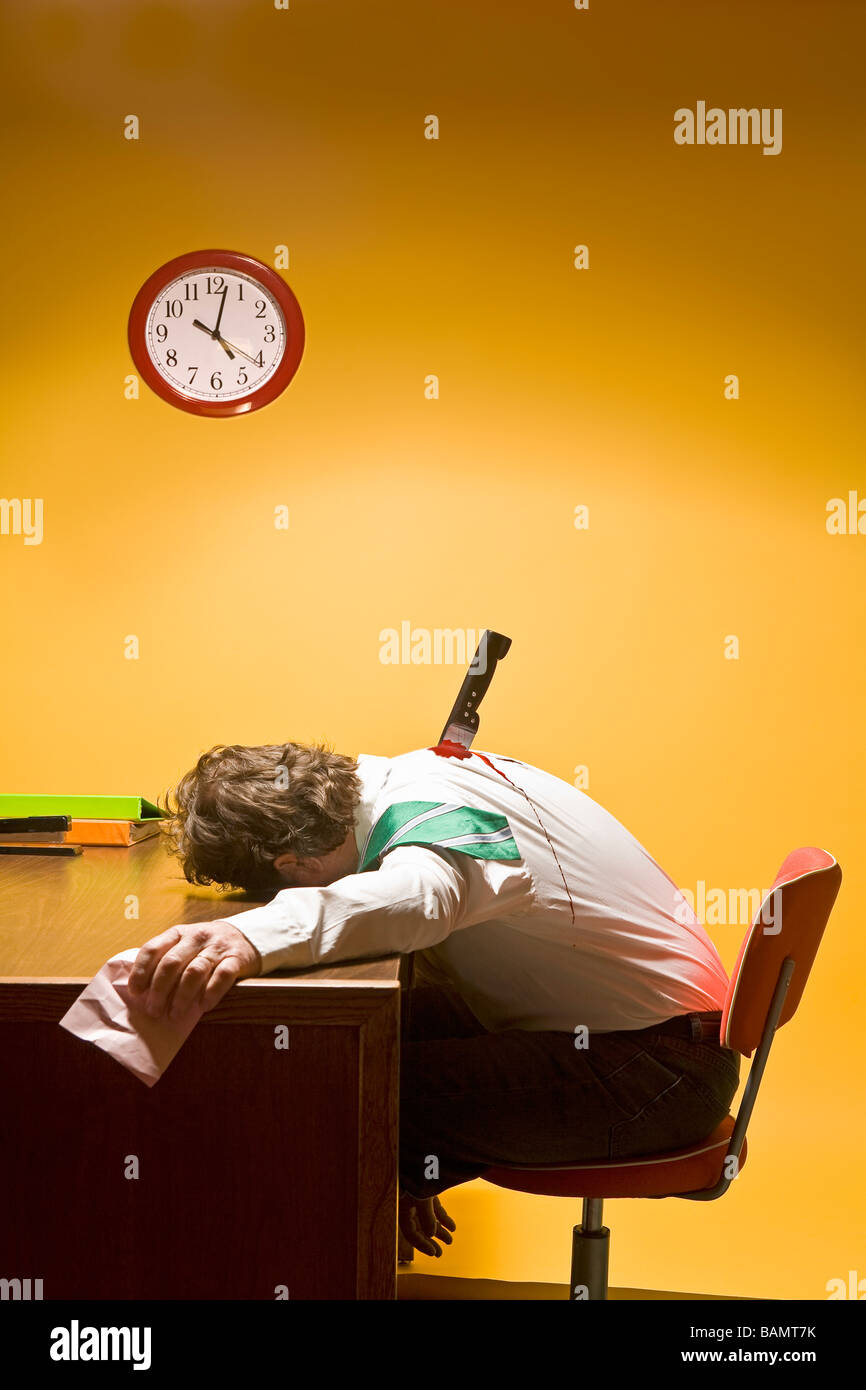 Stabbed in the back at the office Stock Photo - Alamy