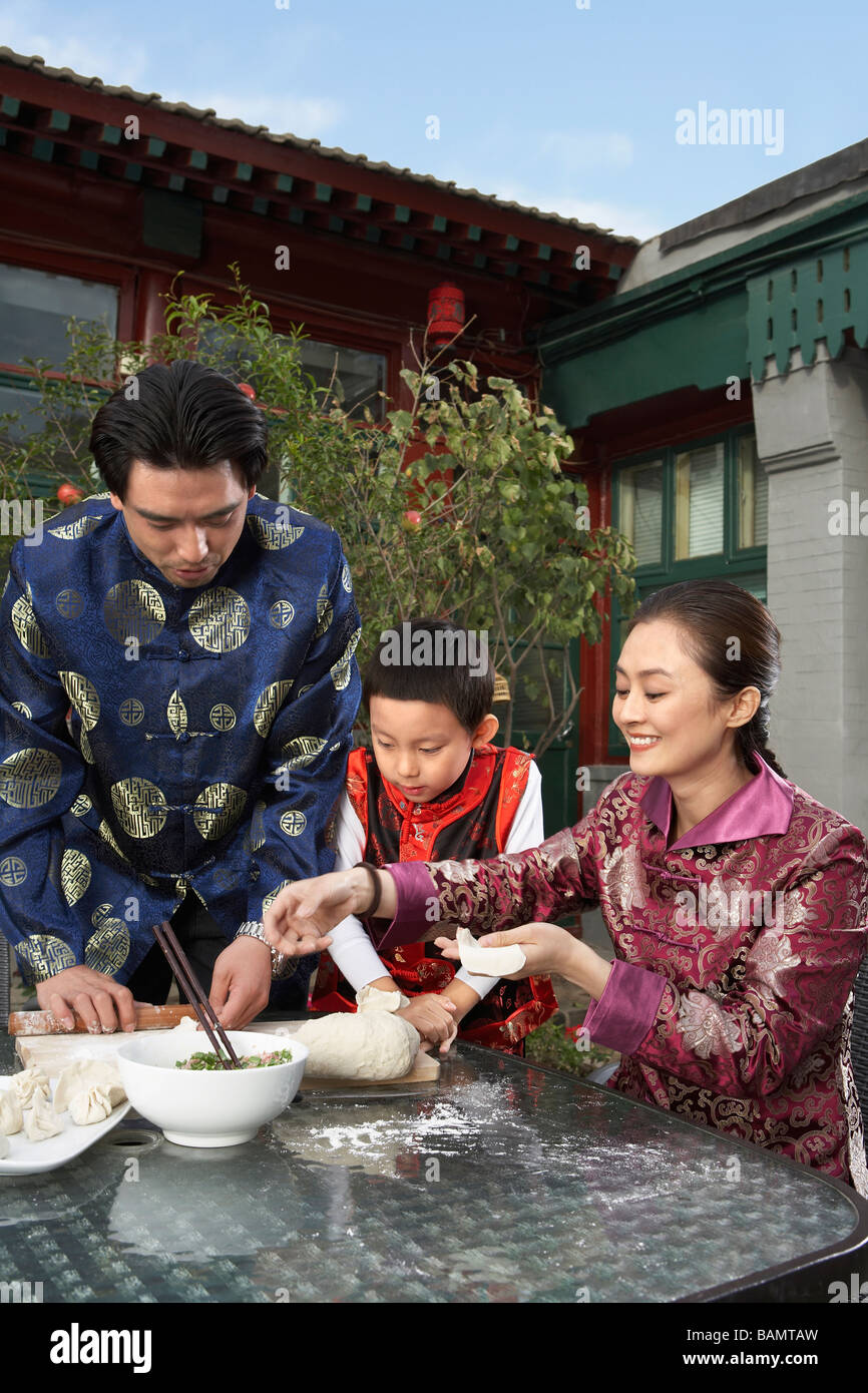 Family Making Dumplings In Courtyard Stock Photo - Alamy