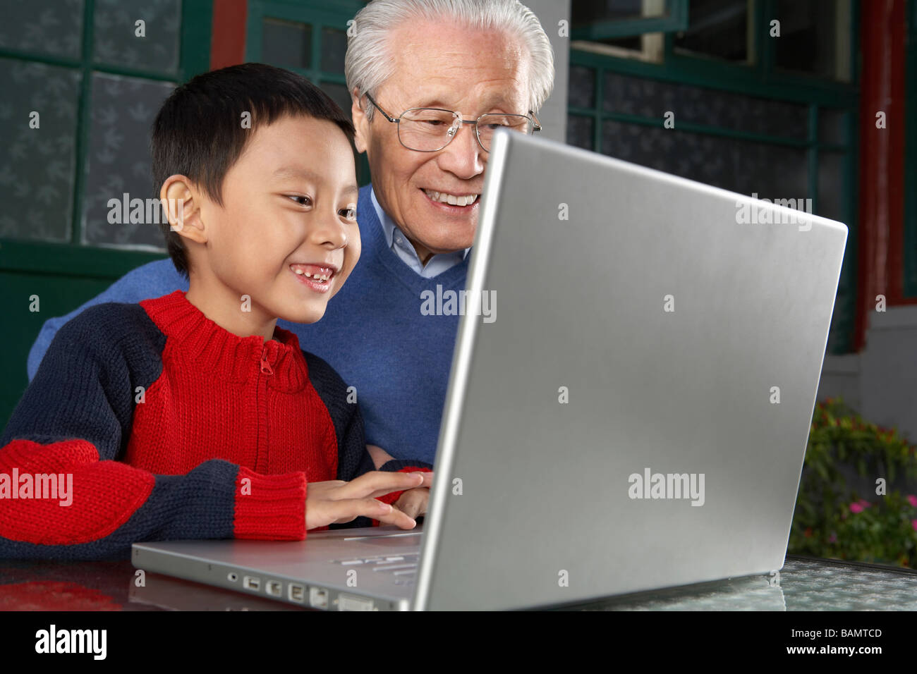 Grandfather And Son Using Laptop Stock Photo - Alamy