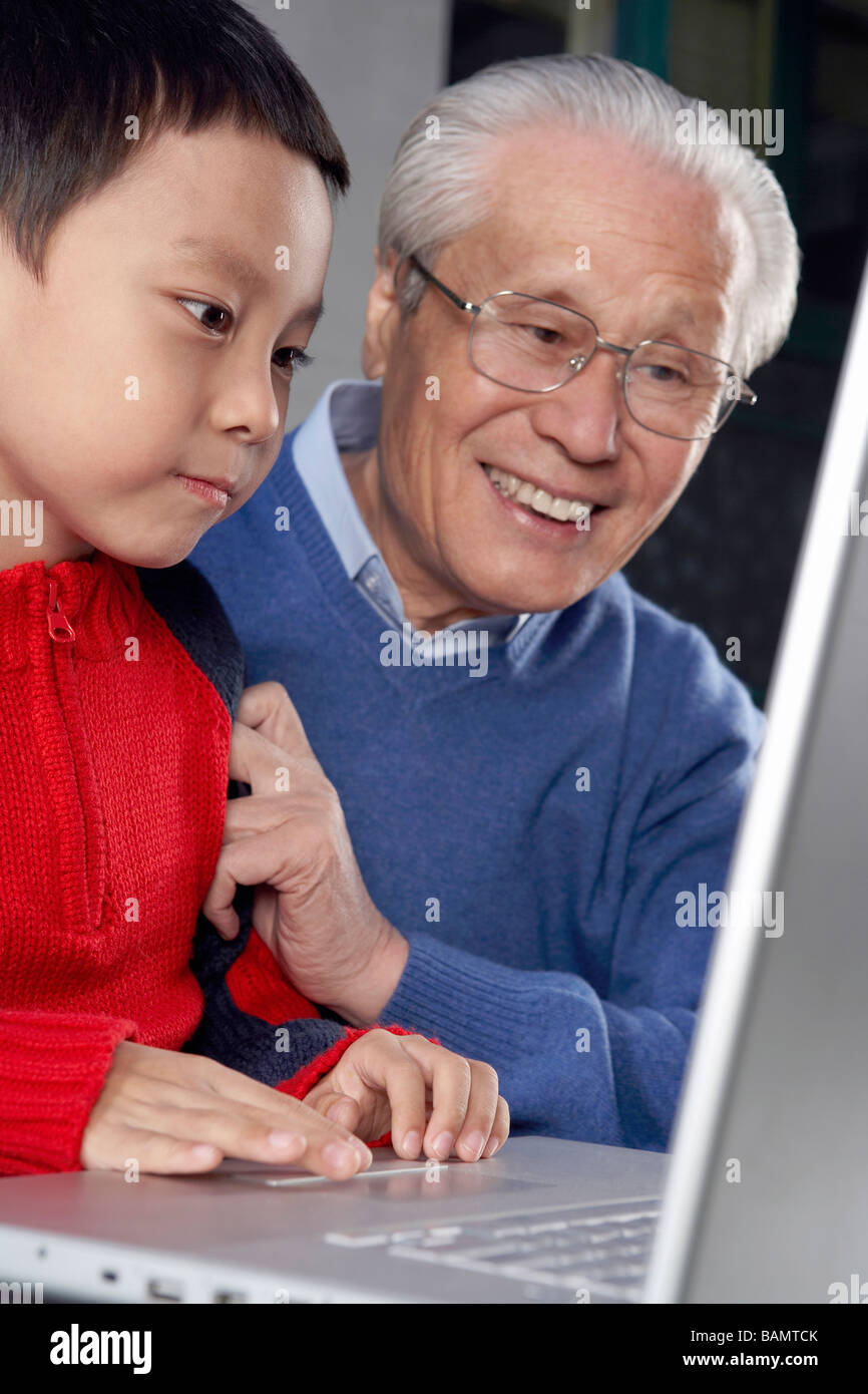 Grandfather And Son Using Laptop Stock Photo - Alamy