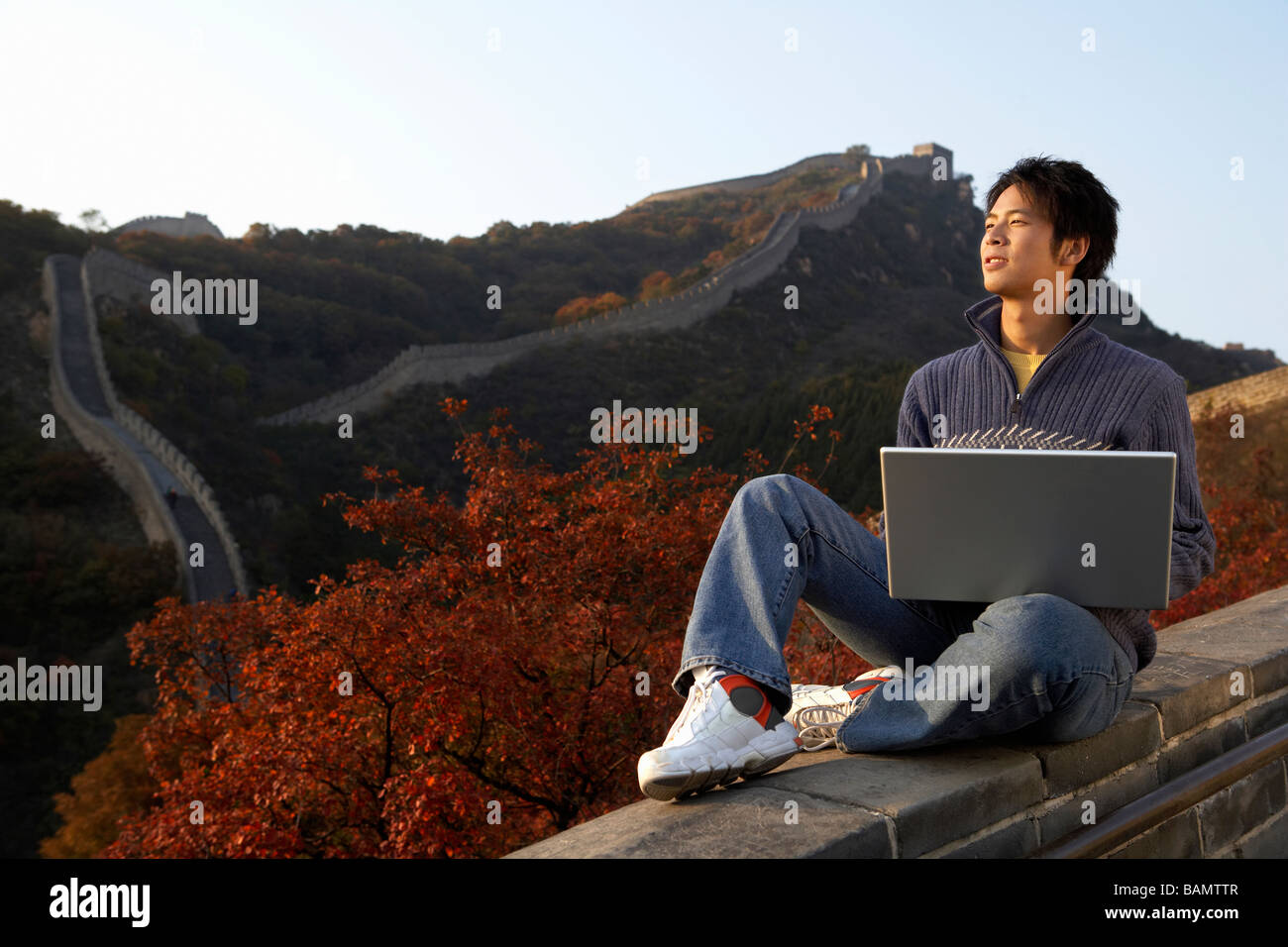 Young Man Uses Laptop On The Great Wall Of China Stock Photo - Alamy