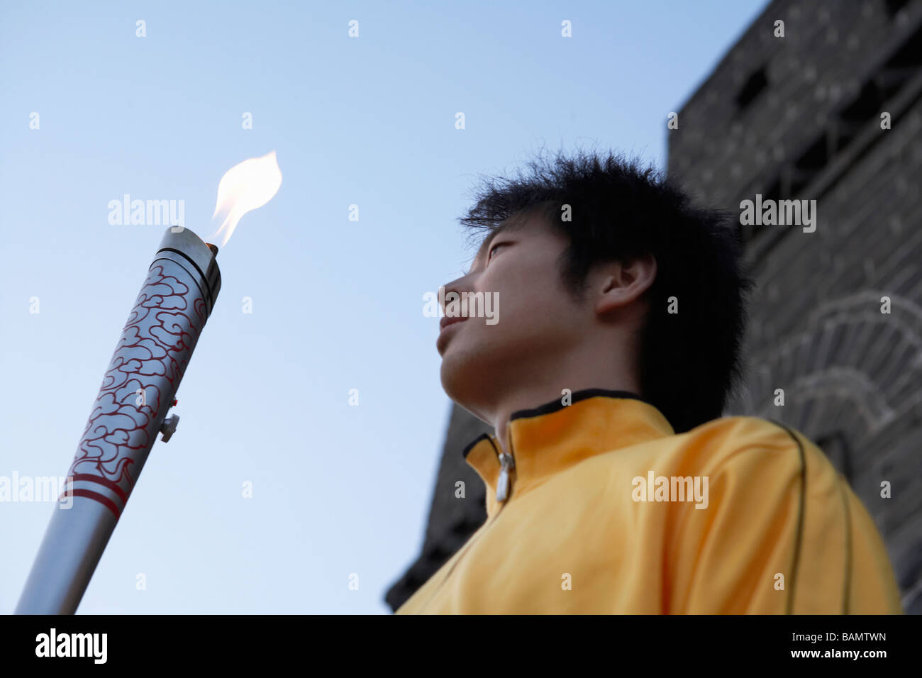 Young Man Holds Olympic Torch At The UNESCO World Heritage Site Stock ...