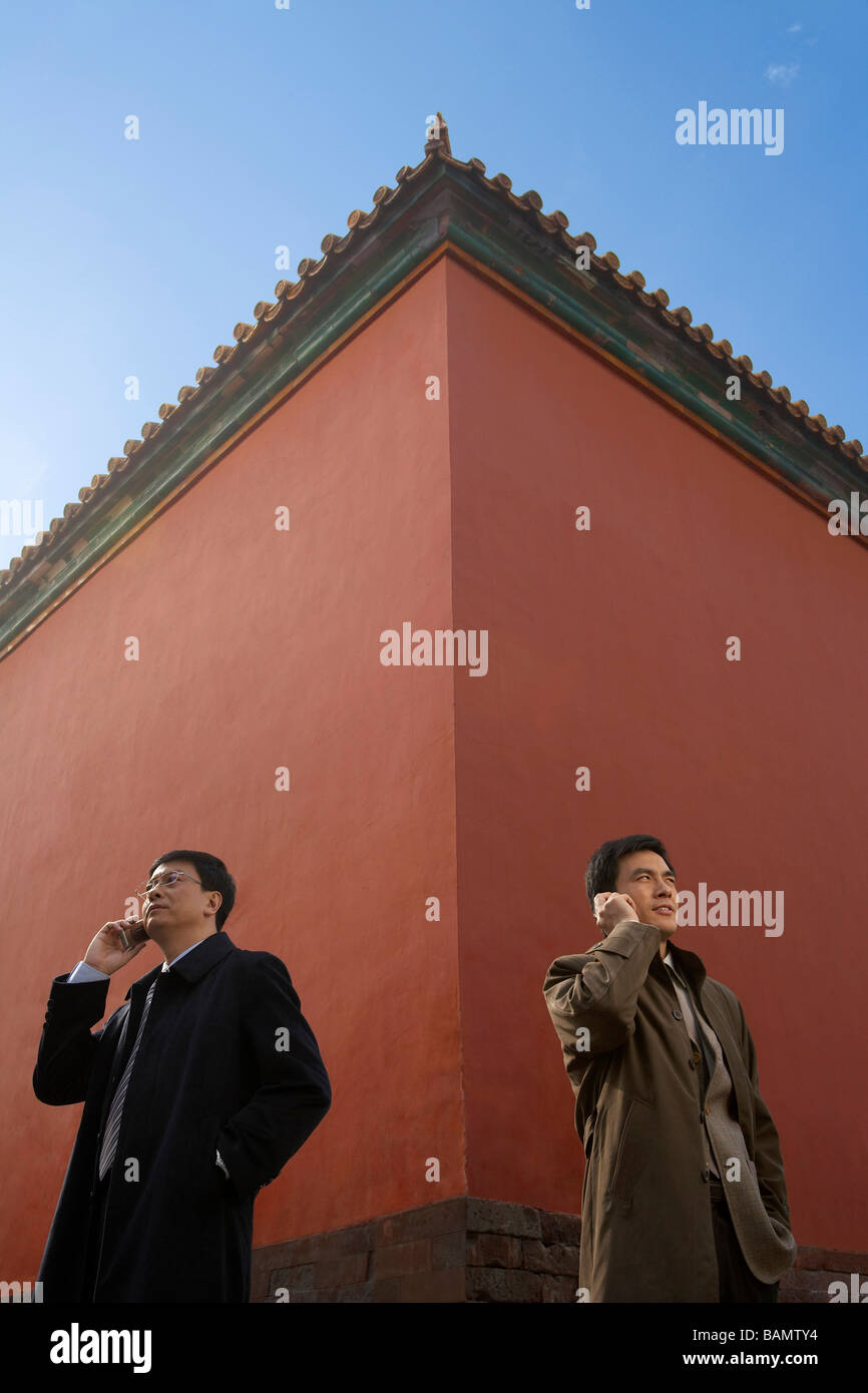 Businessmen Next To Building Exterior Stock Photo - Alamy