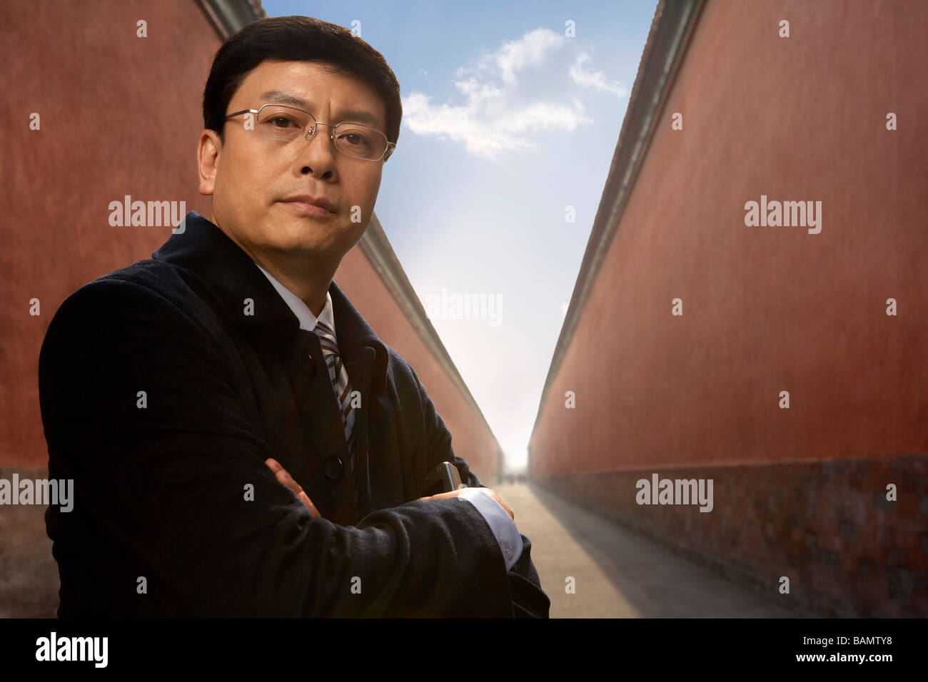 Businessman Standing Next To Building Exterior Stock Photo - Alamy