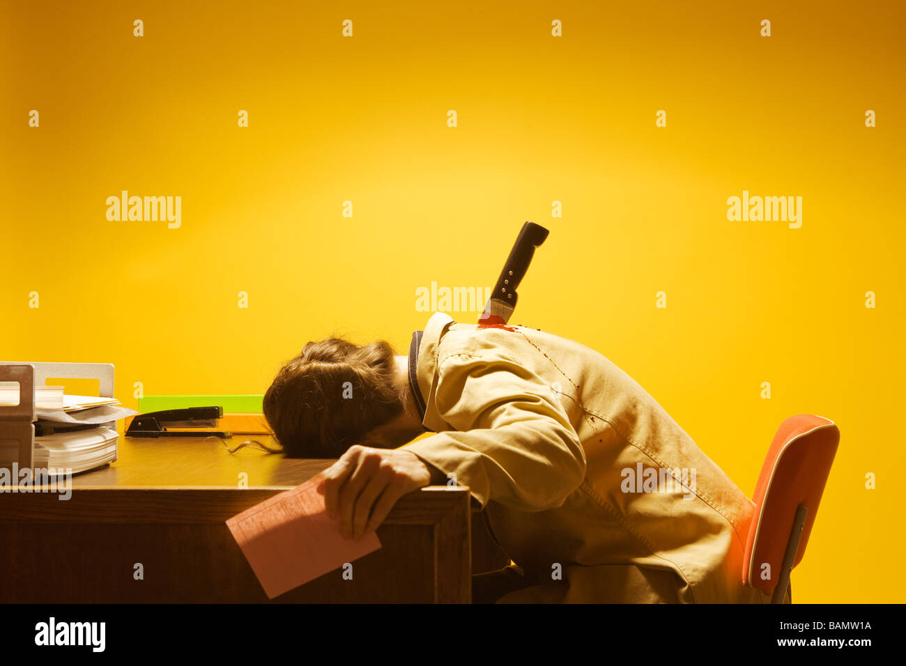 Stabbed in the back at the office Stock Photo - Alamy