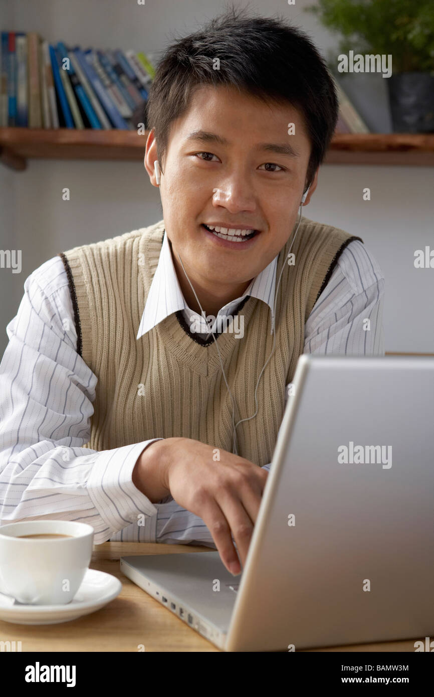 Man Using Laptop Computer With Headphones On Stock Photo - Alamy